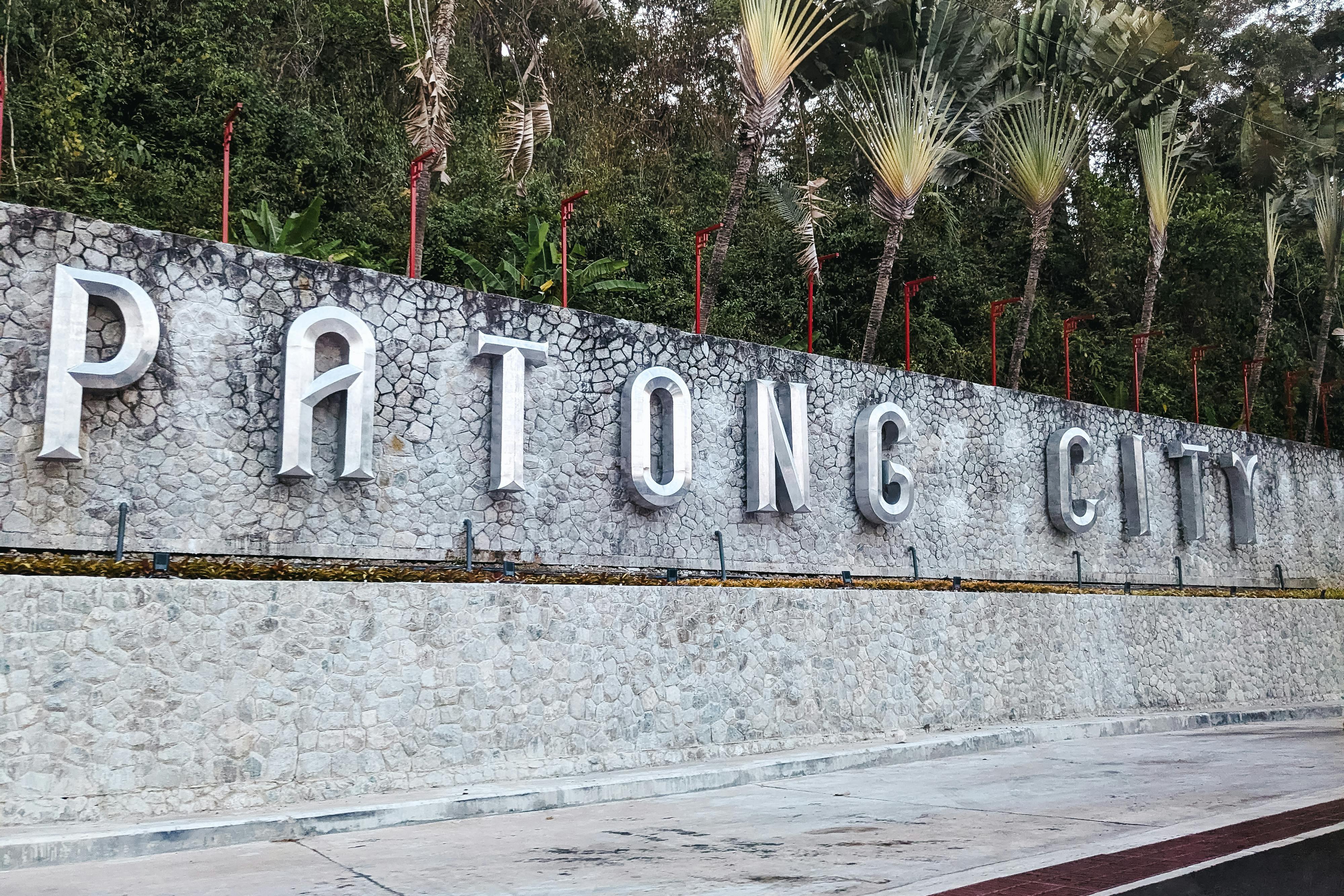 Iconic Patong City Sign with Palm Trees · Free Stock Photo