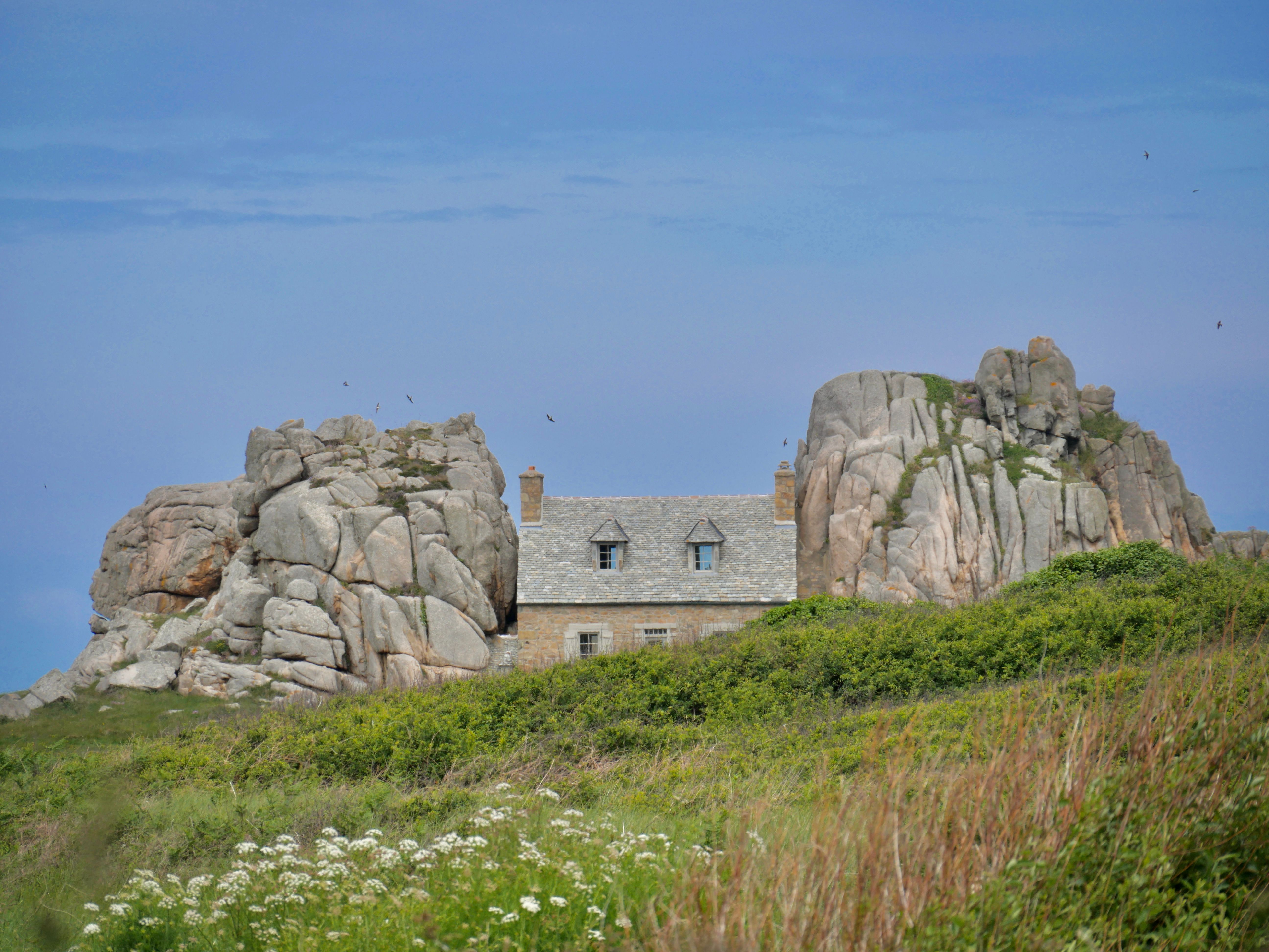 Charming Stone House Amidst Seaside Rocks · Free Stock Photo