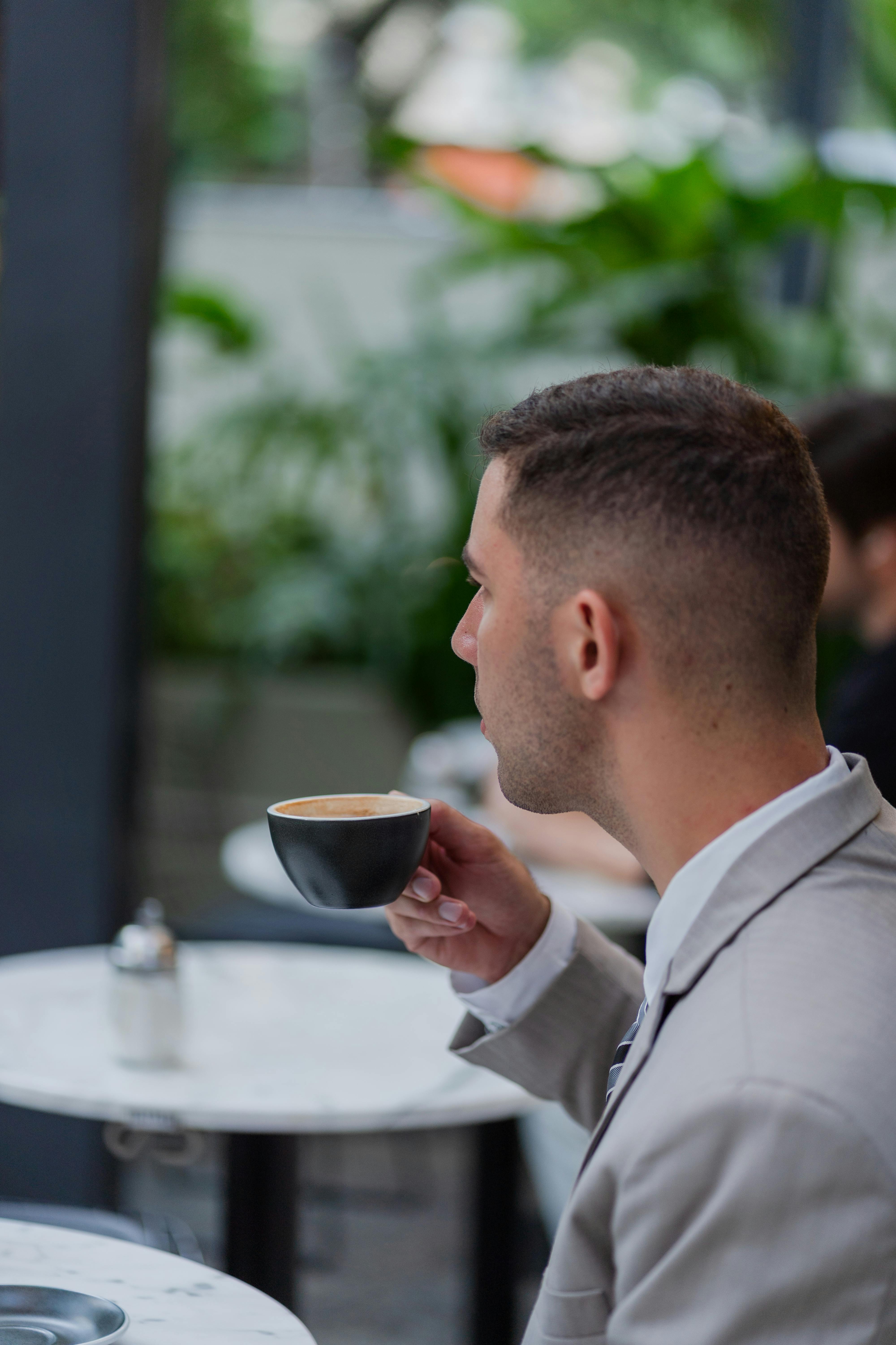 Businessman Enjoying Coffee at Outdoor Café · Free Stock Photo