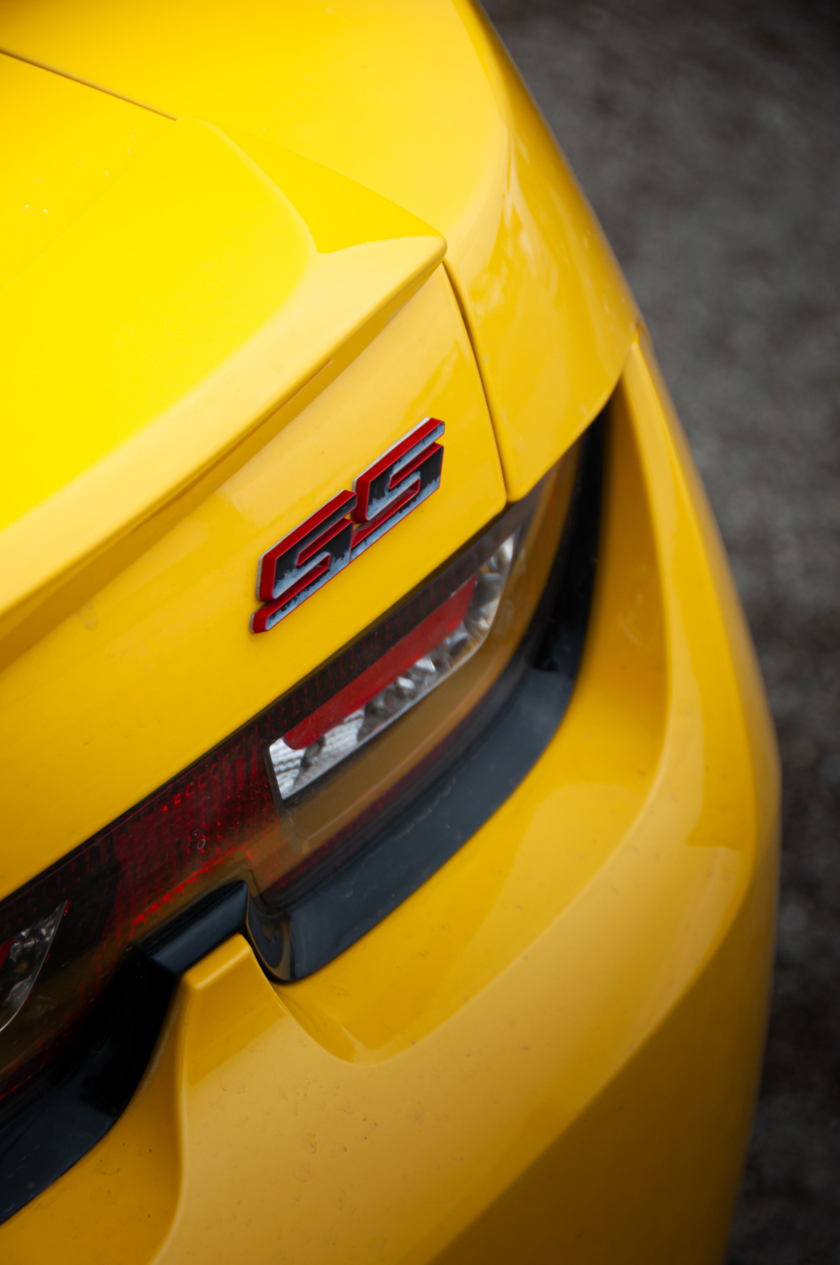 Close-up of Yellow Muscle Car with SS Badge · Free Stock Photo
