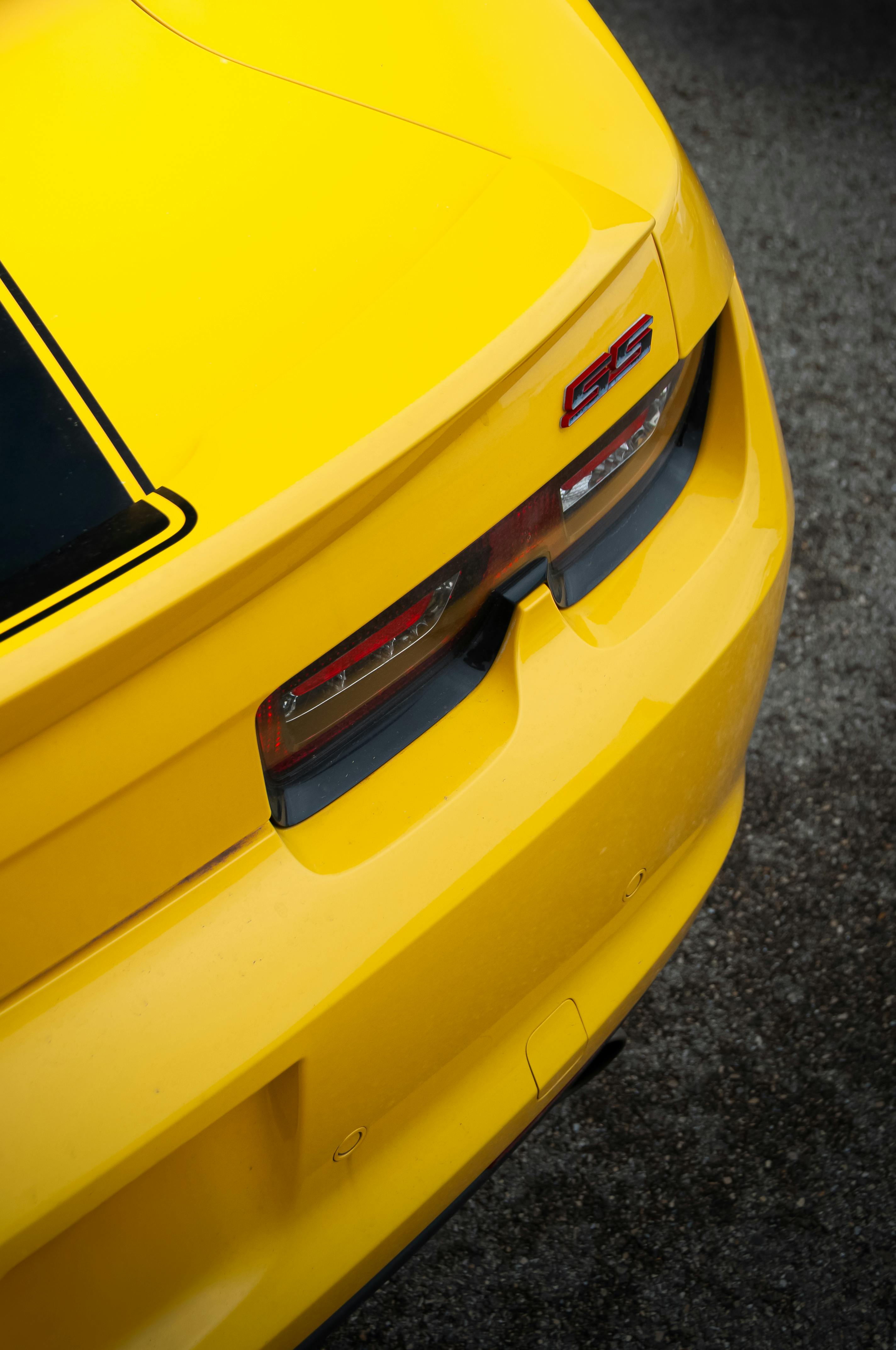 Close-Up of a Yellow Sports Car Rear · Free Stock Photo