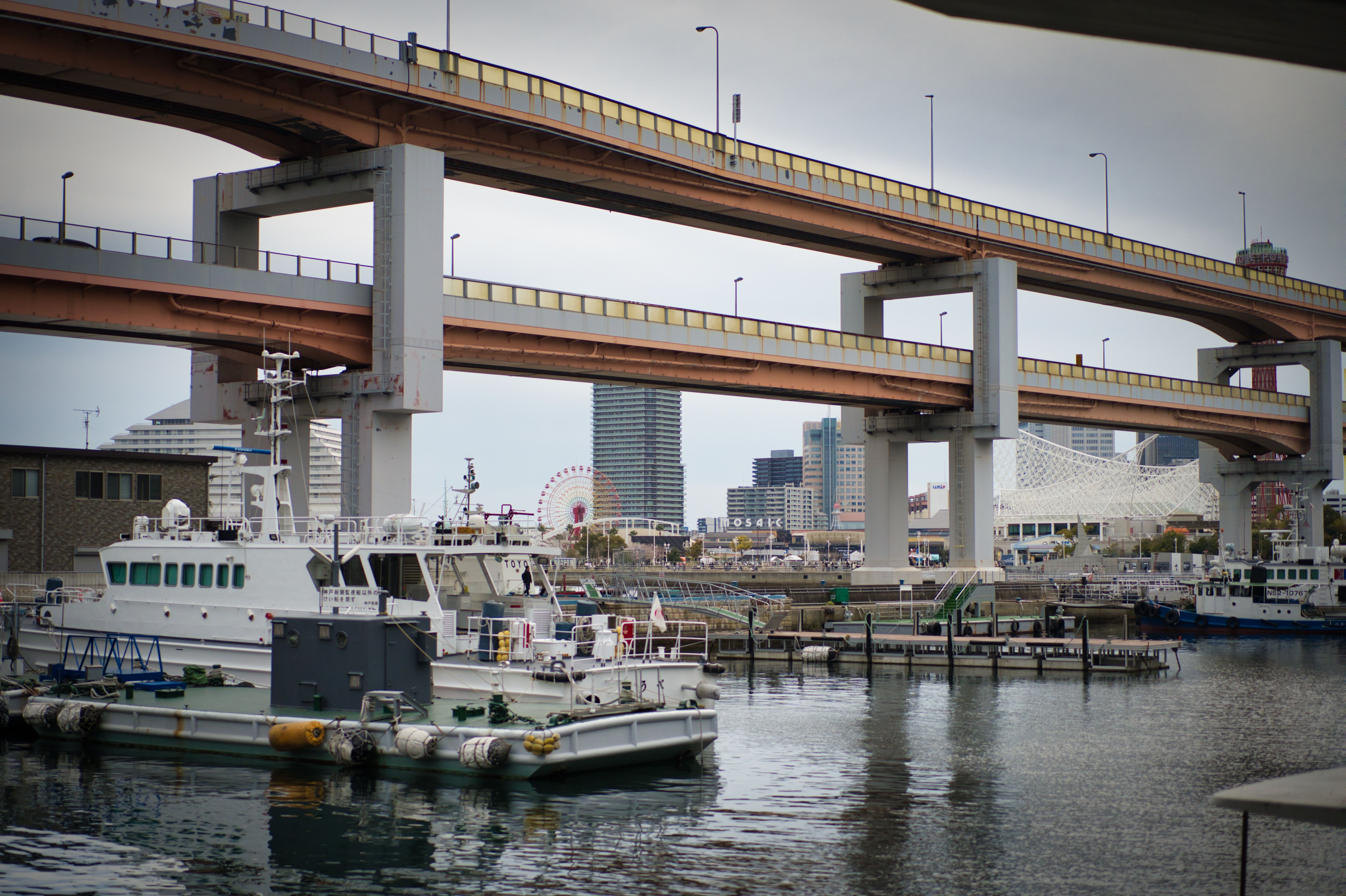 City Waterfront with Elevated Highway and Boats · Free Stock Photo