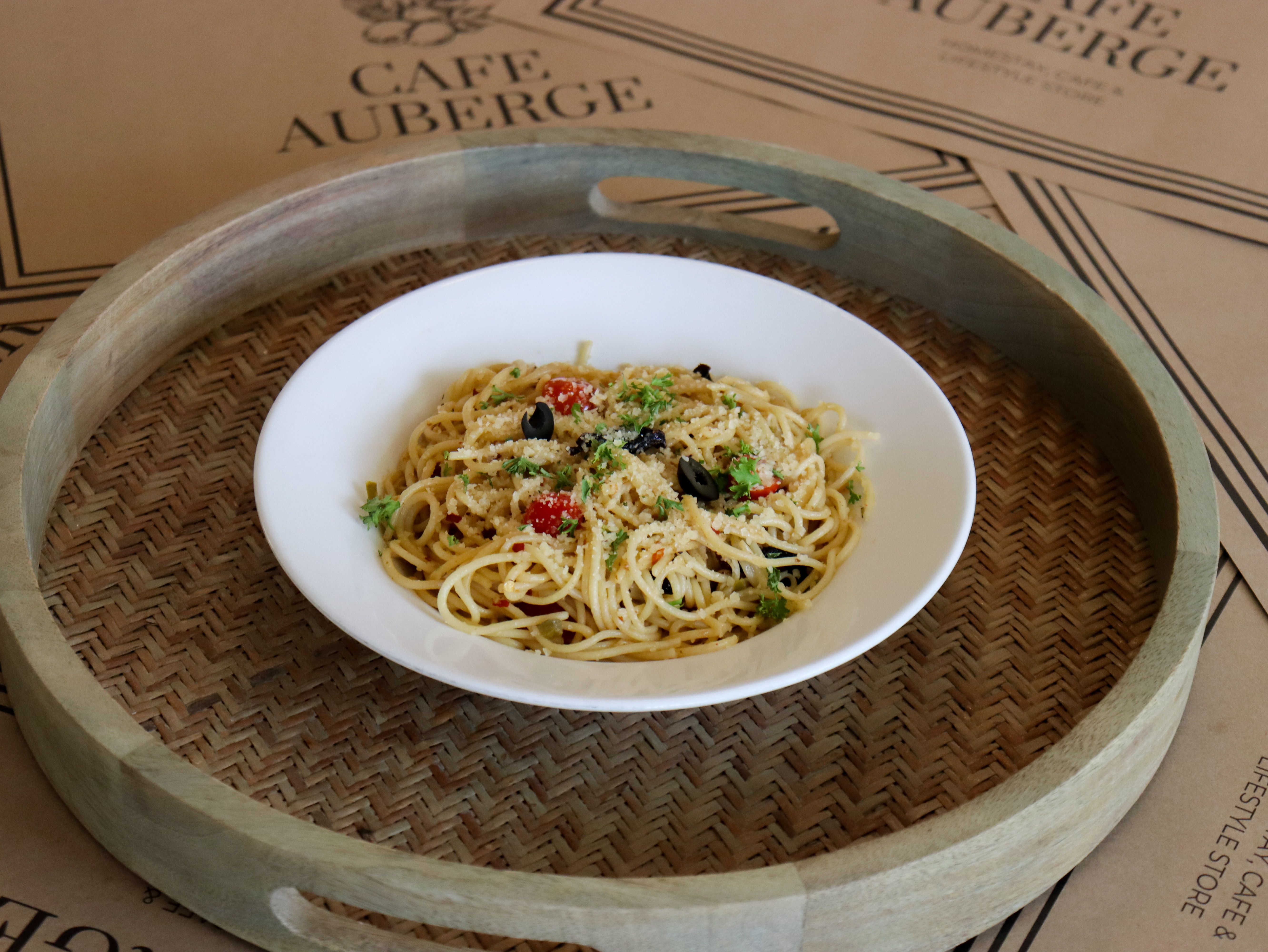 Delicious Spaghetti with Black Olives in a Cafe Setting · Free Stock Photo