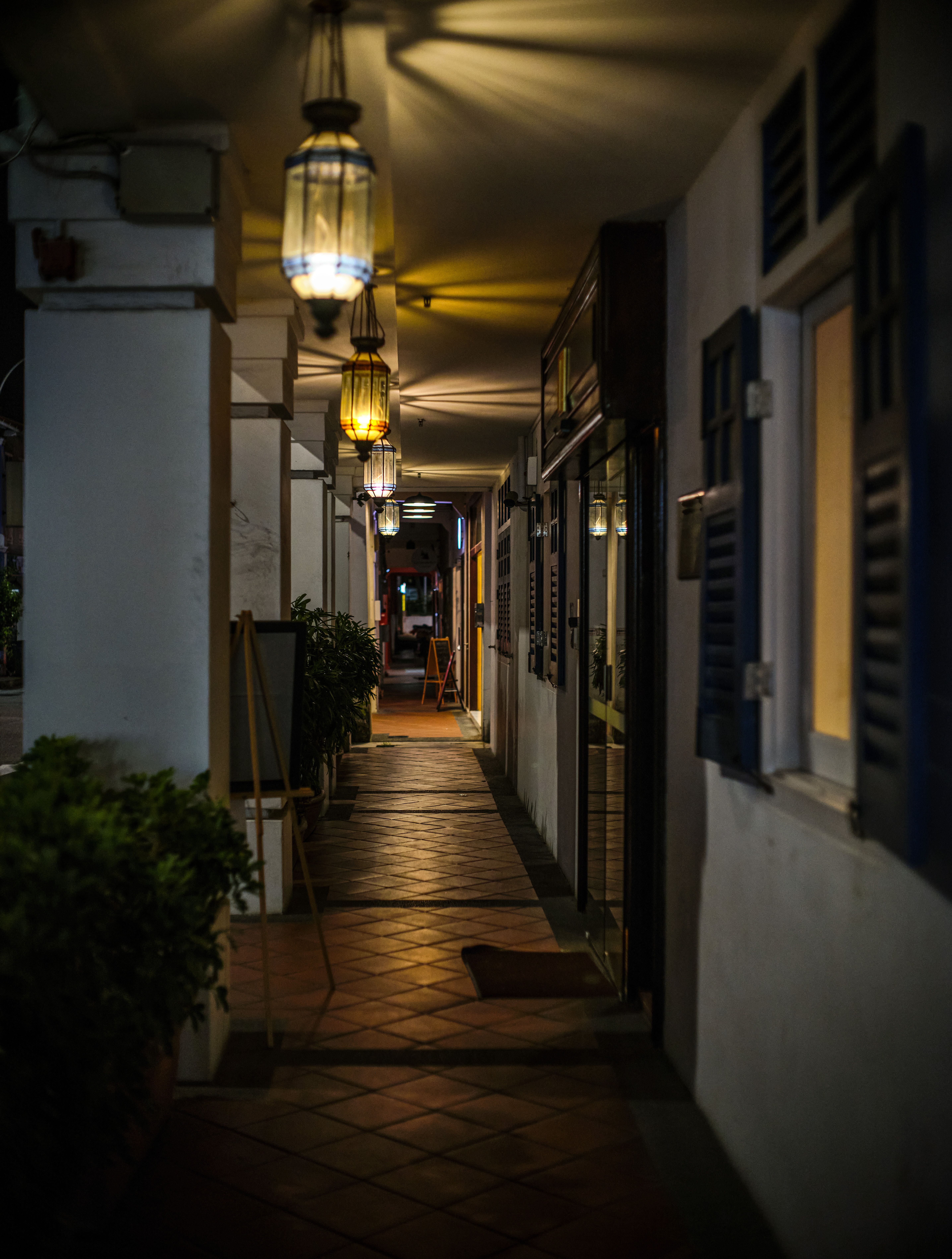 Cozy Nighttime Corridor with Hanging Lanterns · Free Stock Photo
