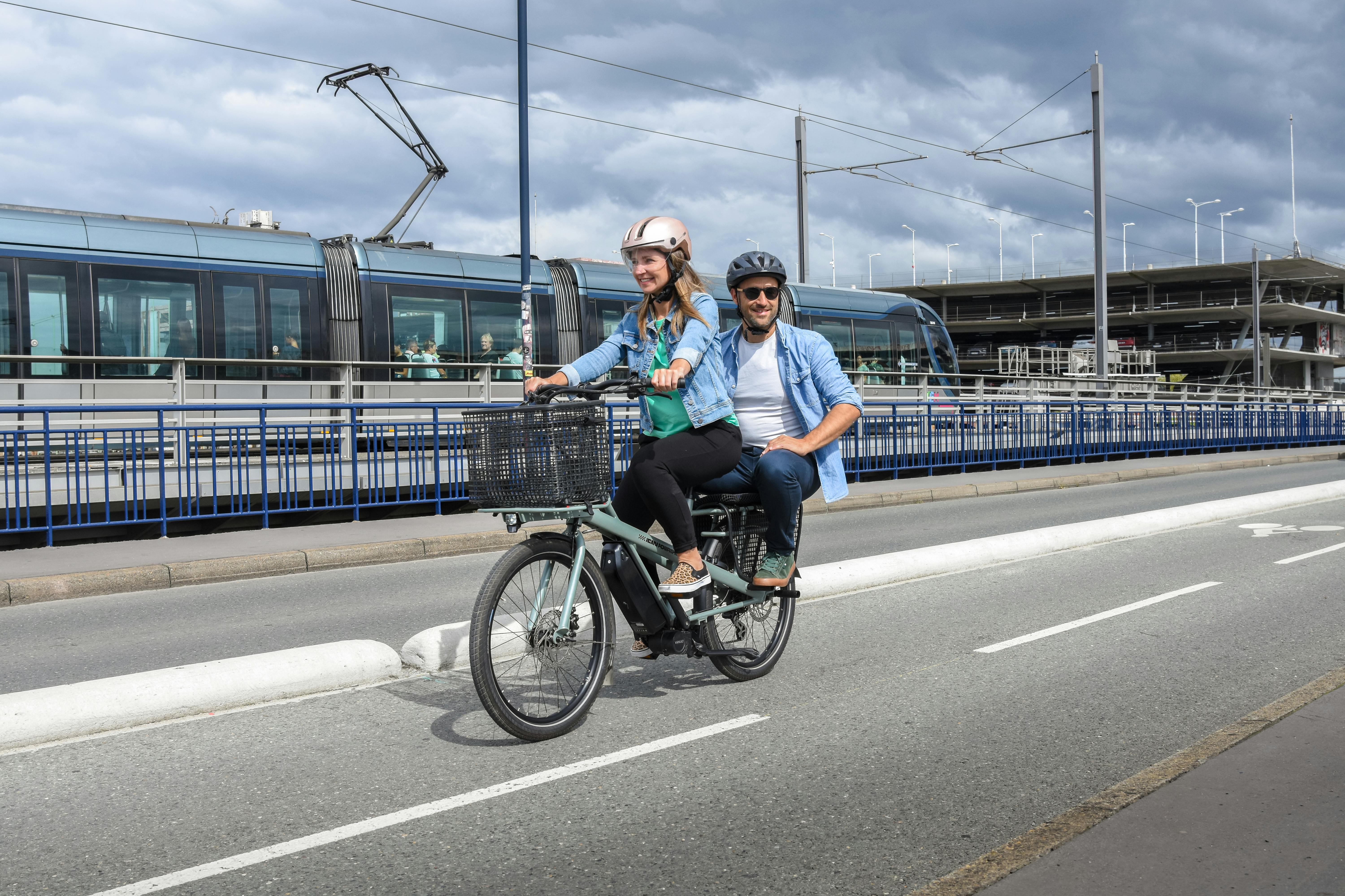 Couple Riding Cargo Bike in Bordeaux · Free Stock Photo