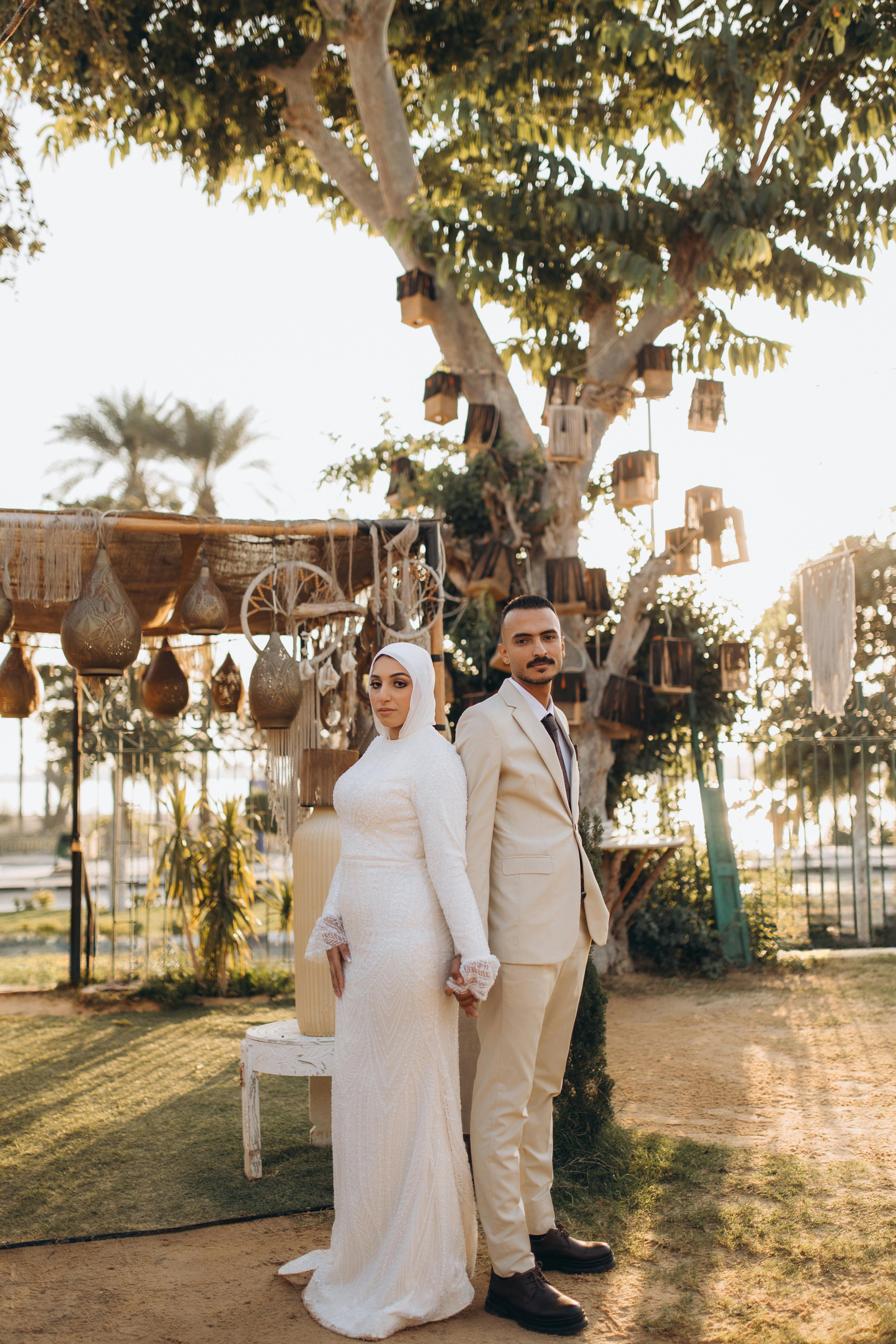 Elegant Outdoor Wedding Portrait Under Tree · Free Stock Photo