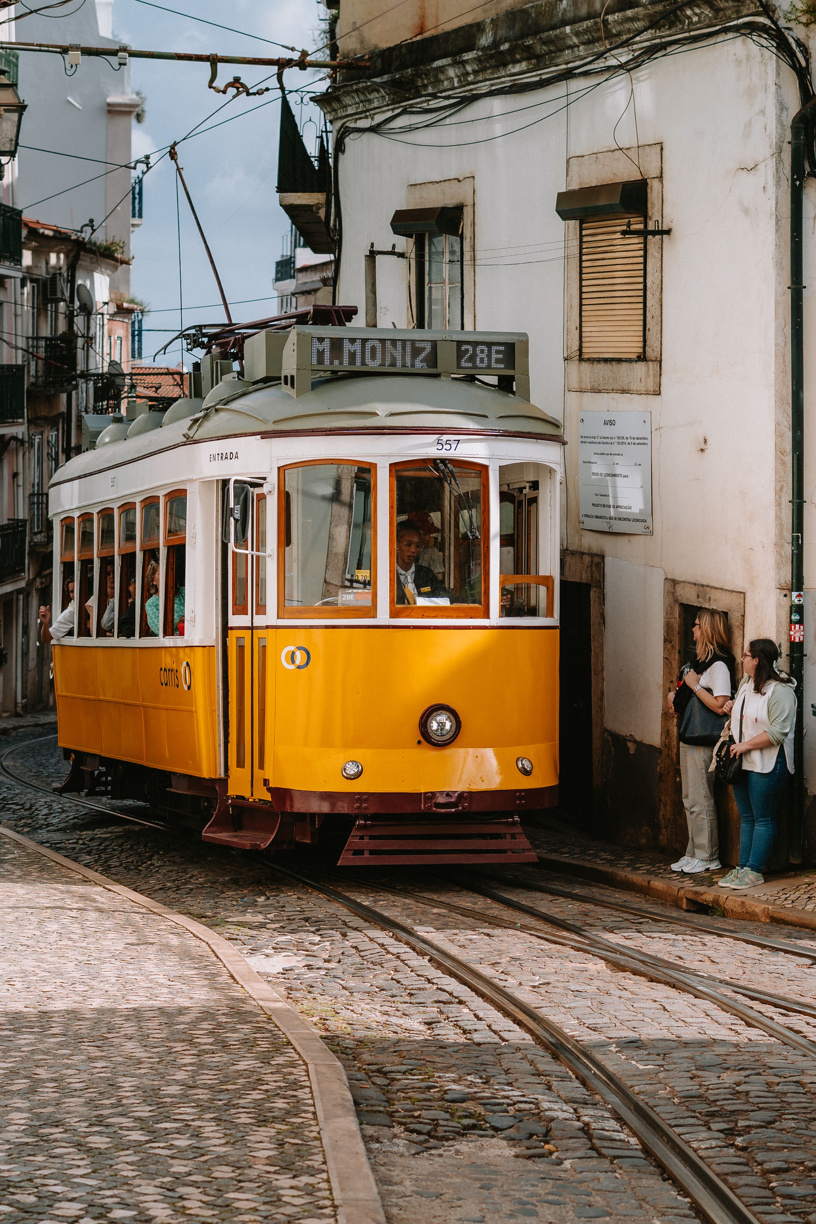 Iconic Yellow Tram in Lisbon's Historic Streets · Free Stock Photo