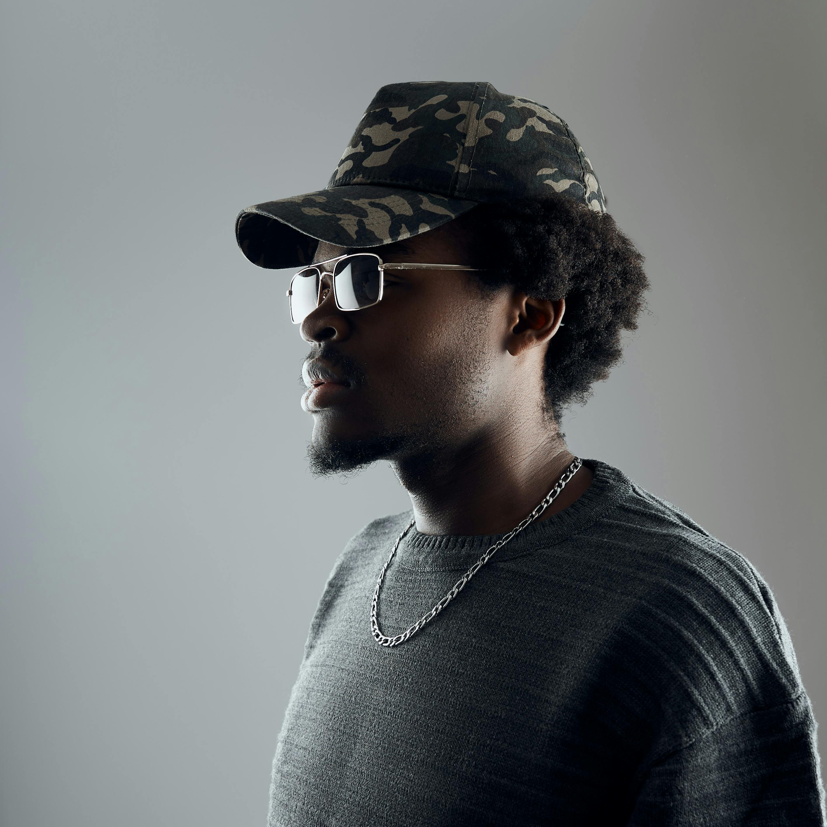 Portrait of a Man with Camouflage Cap and Chain · Free Stock Photo