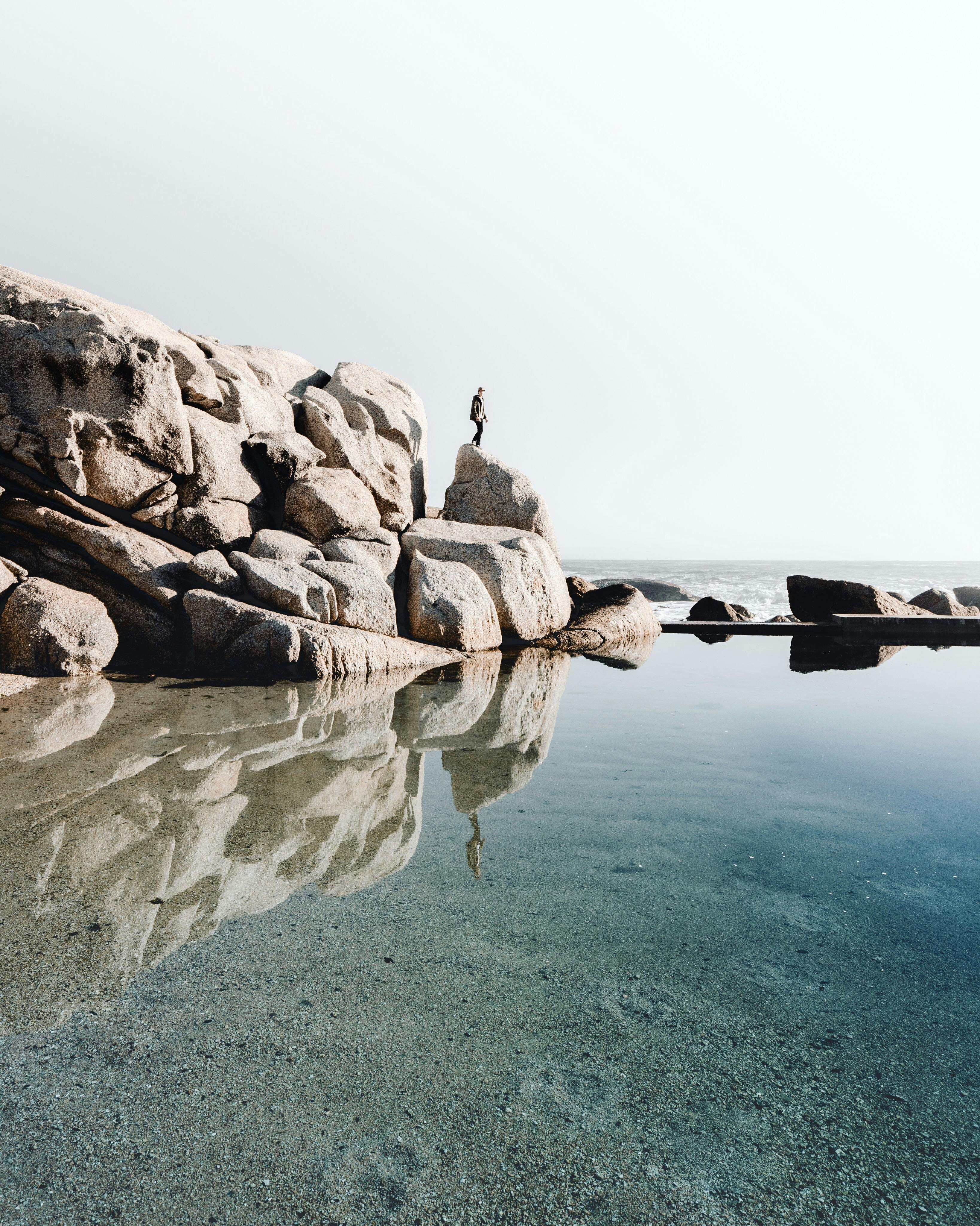 Photo Of Person Standing On Top Of Rock · Free Stock Photo