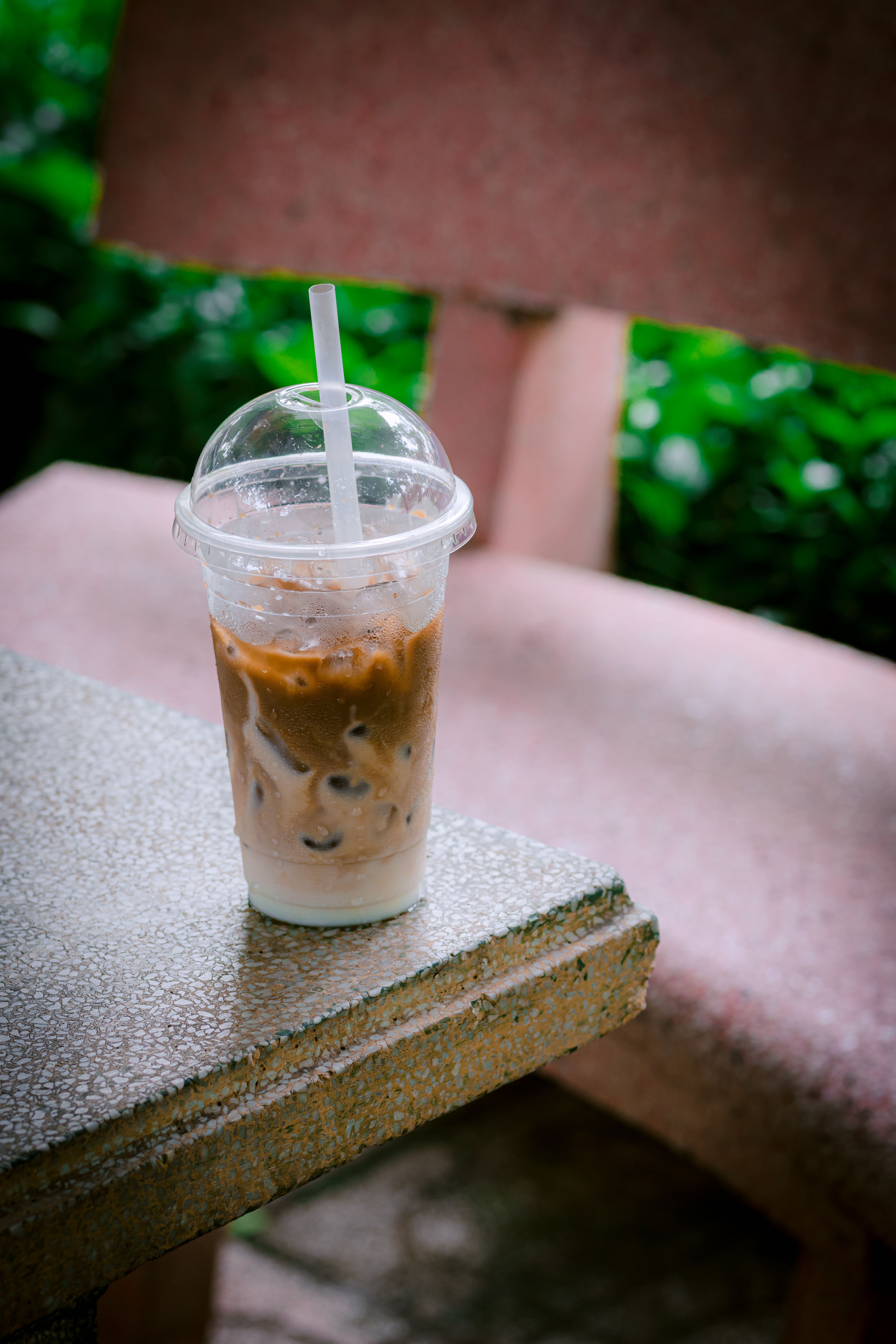 Iced Coffee in Plastic Cup on Outdoor Table · Free Stock Photo