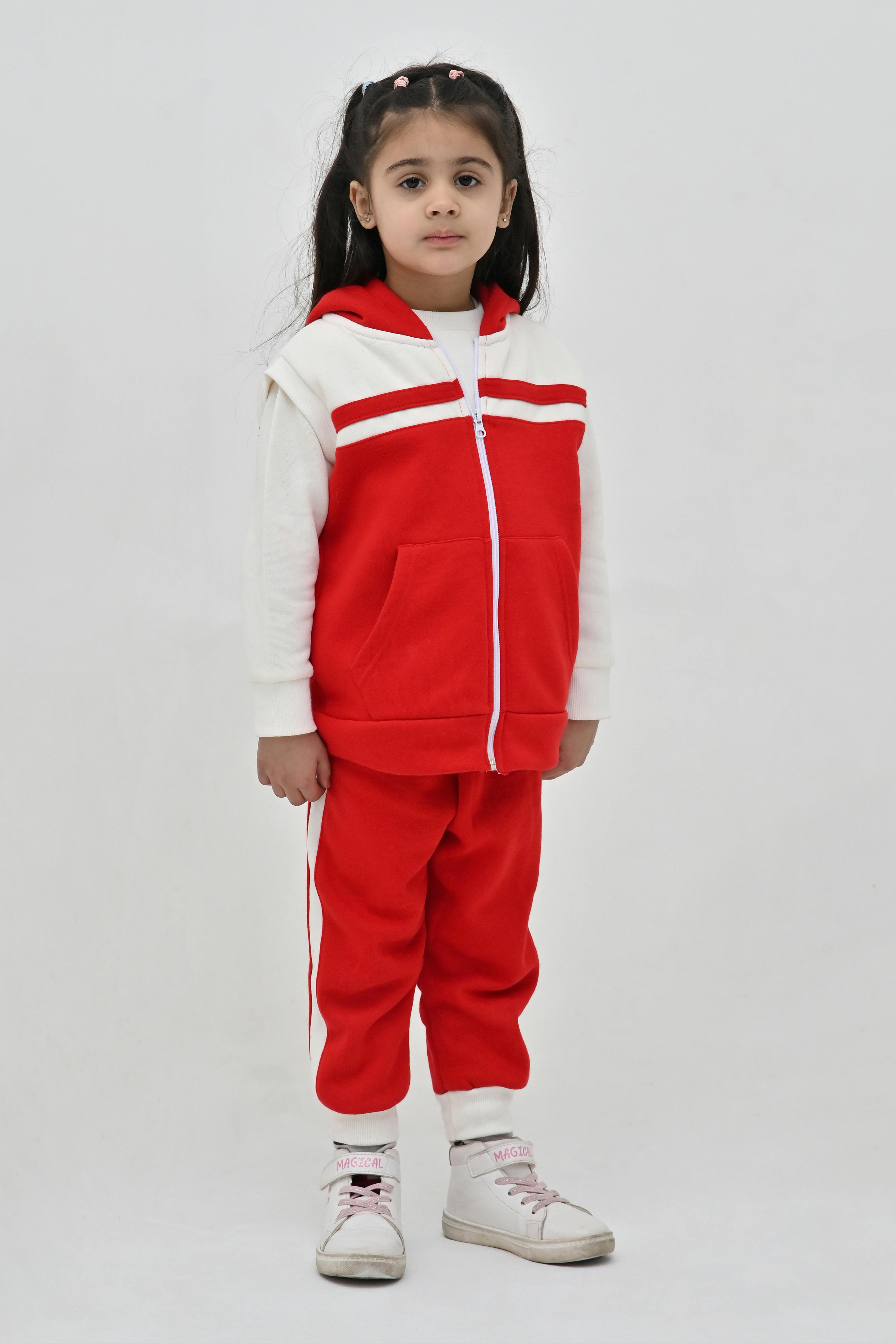 Young Girl in Red Tracksuit Standing Indoors · Free Stock Photo