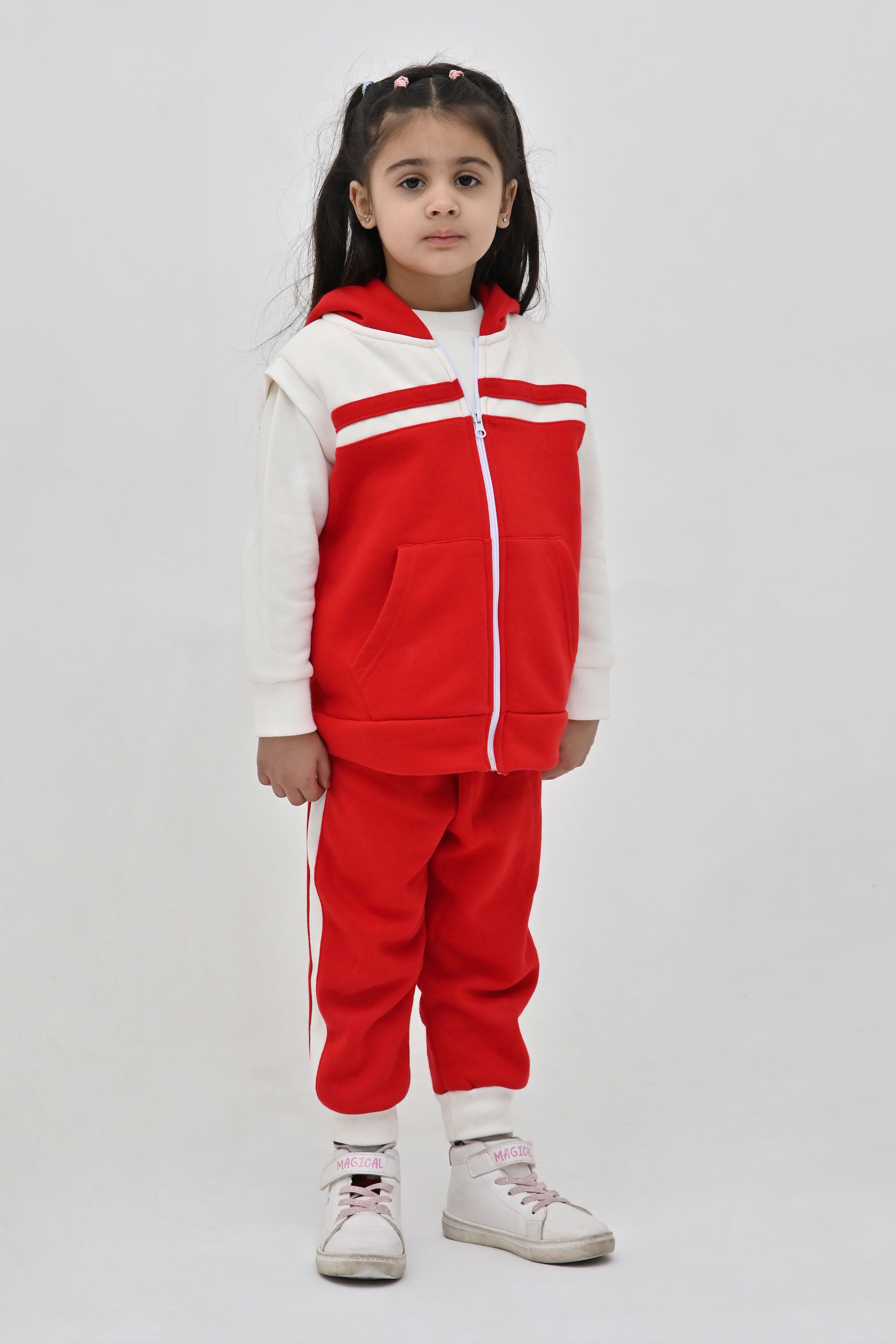 Young Girl in Red Tracksuit Standing Indoors · Free Stock Photo