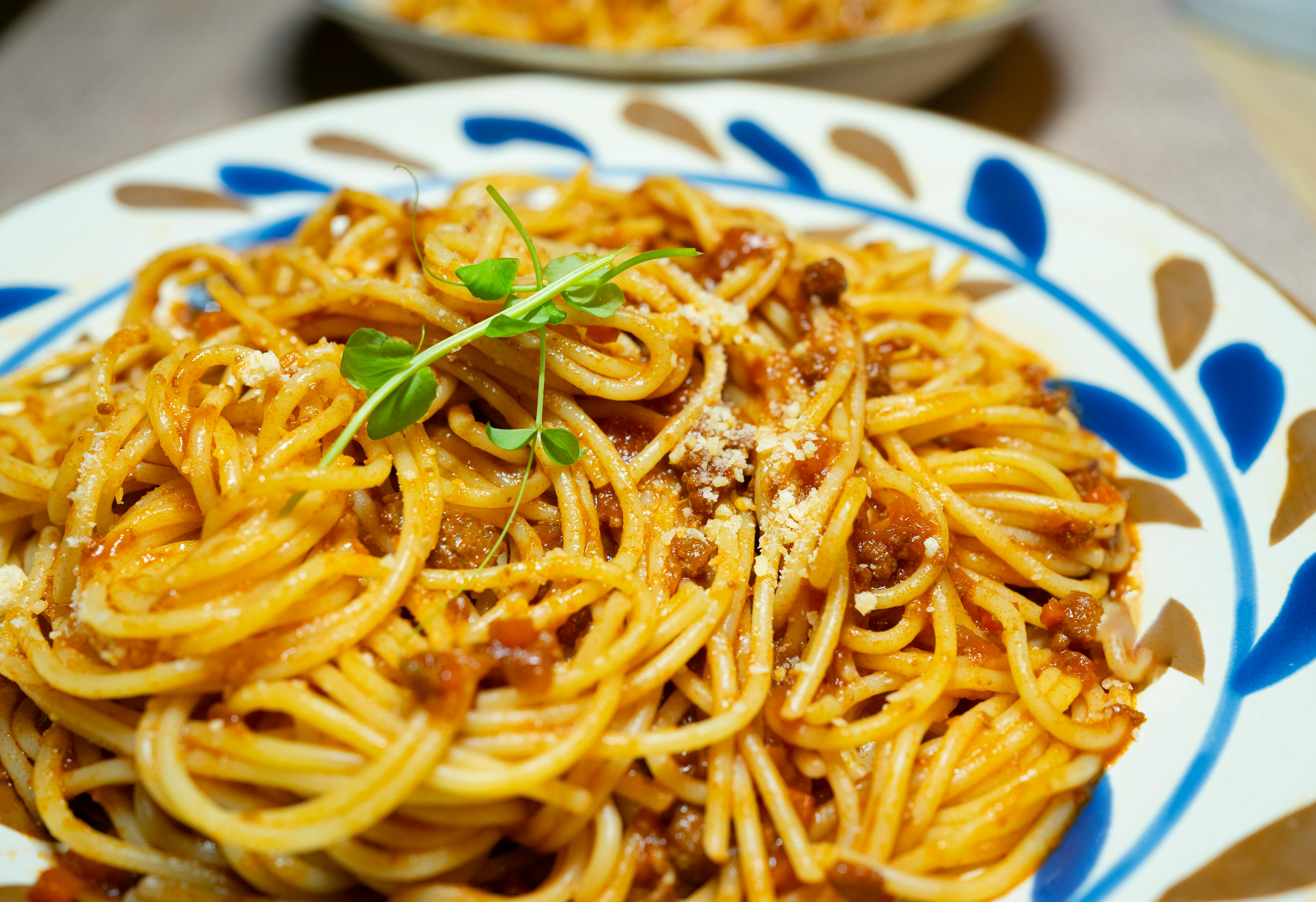 Delicious Spaghetti Bolognese with Fresh Herbs · Free Stock Photo