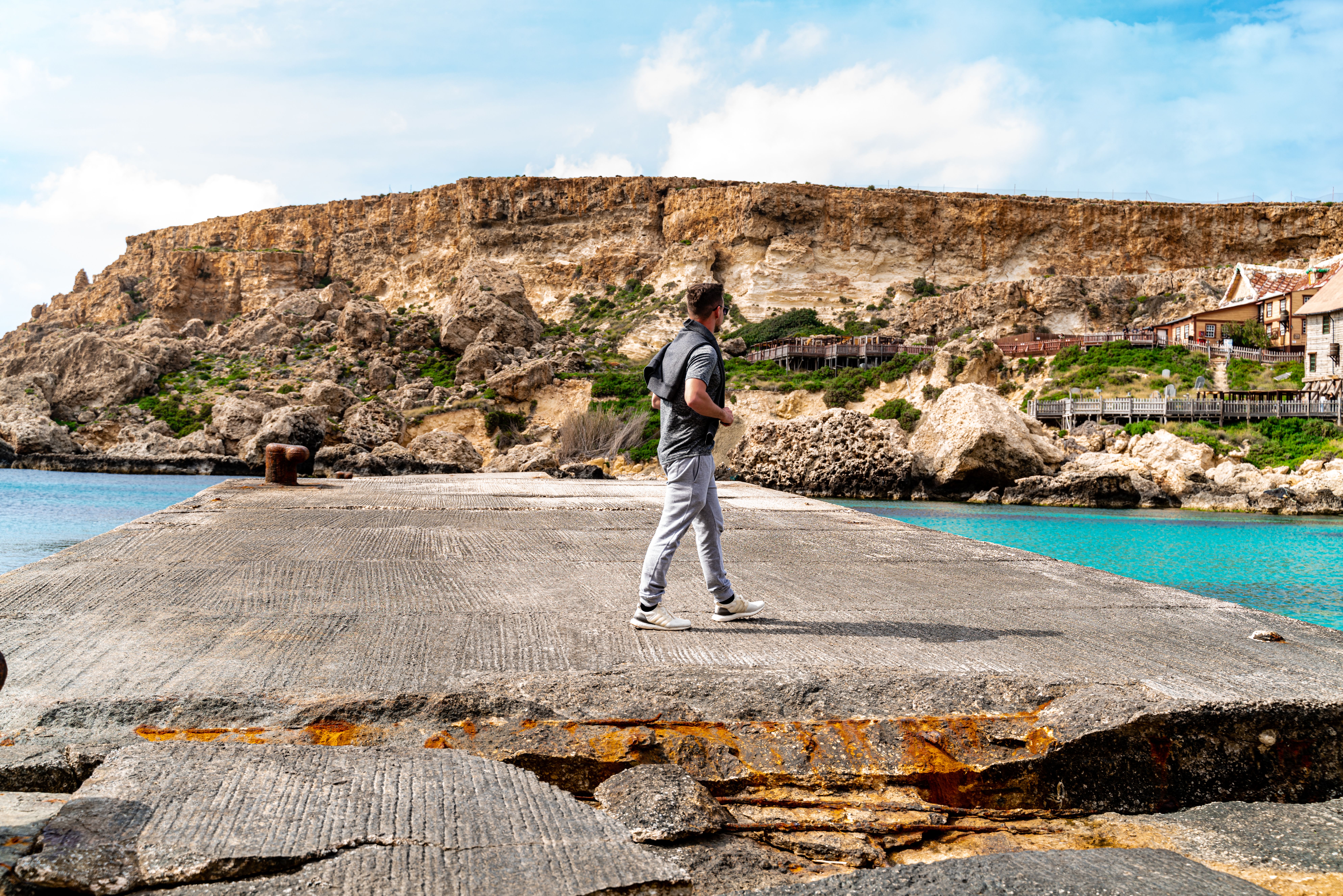 Scenic Explorer Walking on Malta's Coast · Free Stock Photo