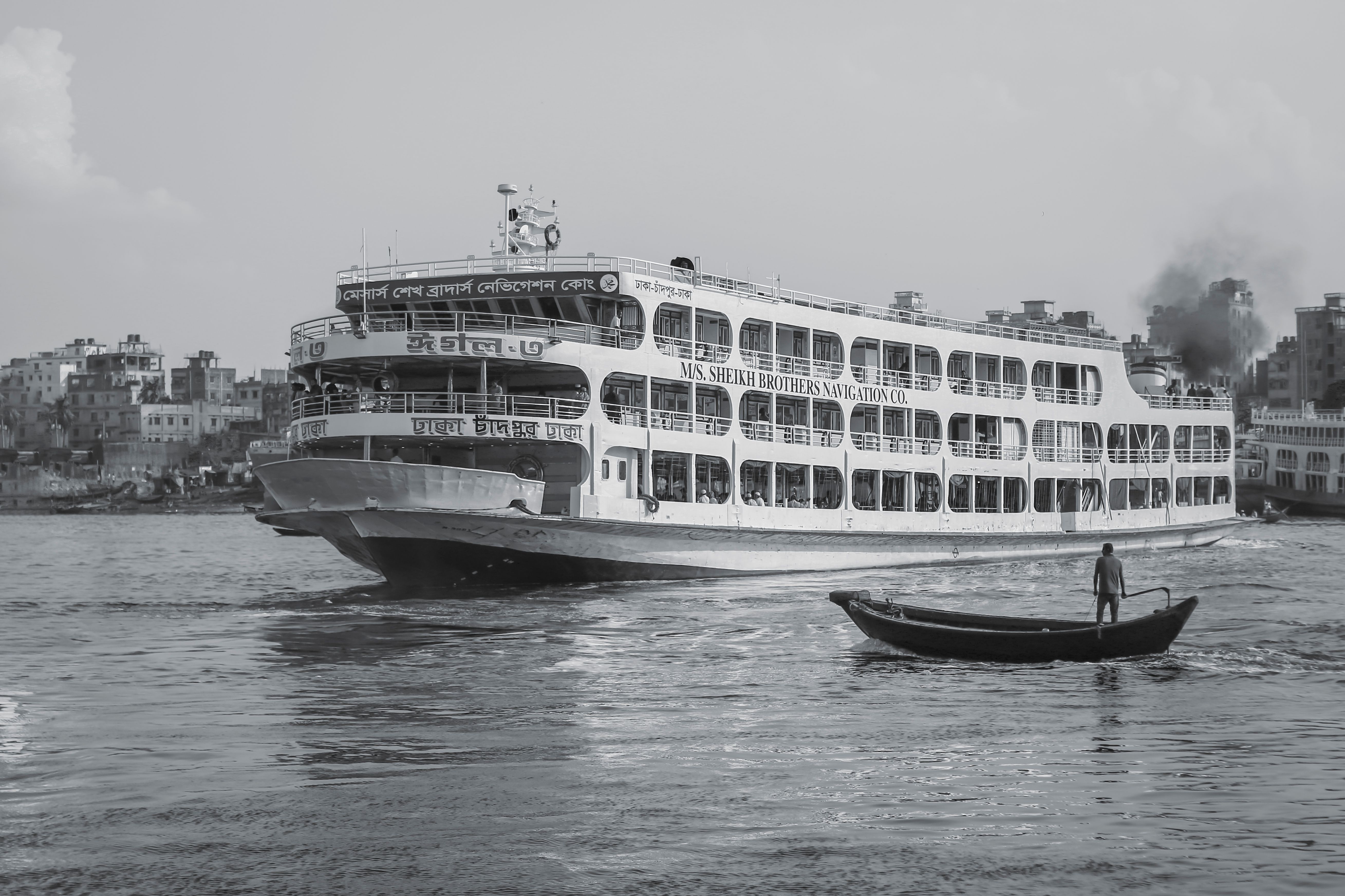 River Ferry and Small Boat on Urban Waterway · Free Stock Photo