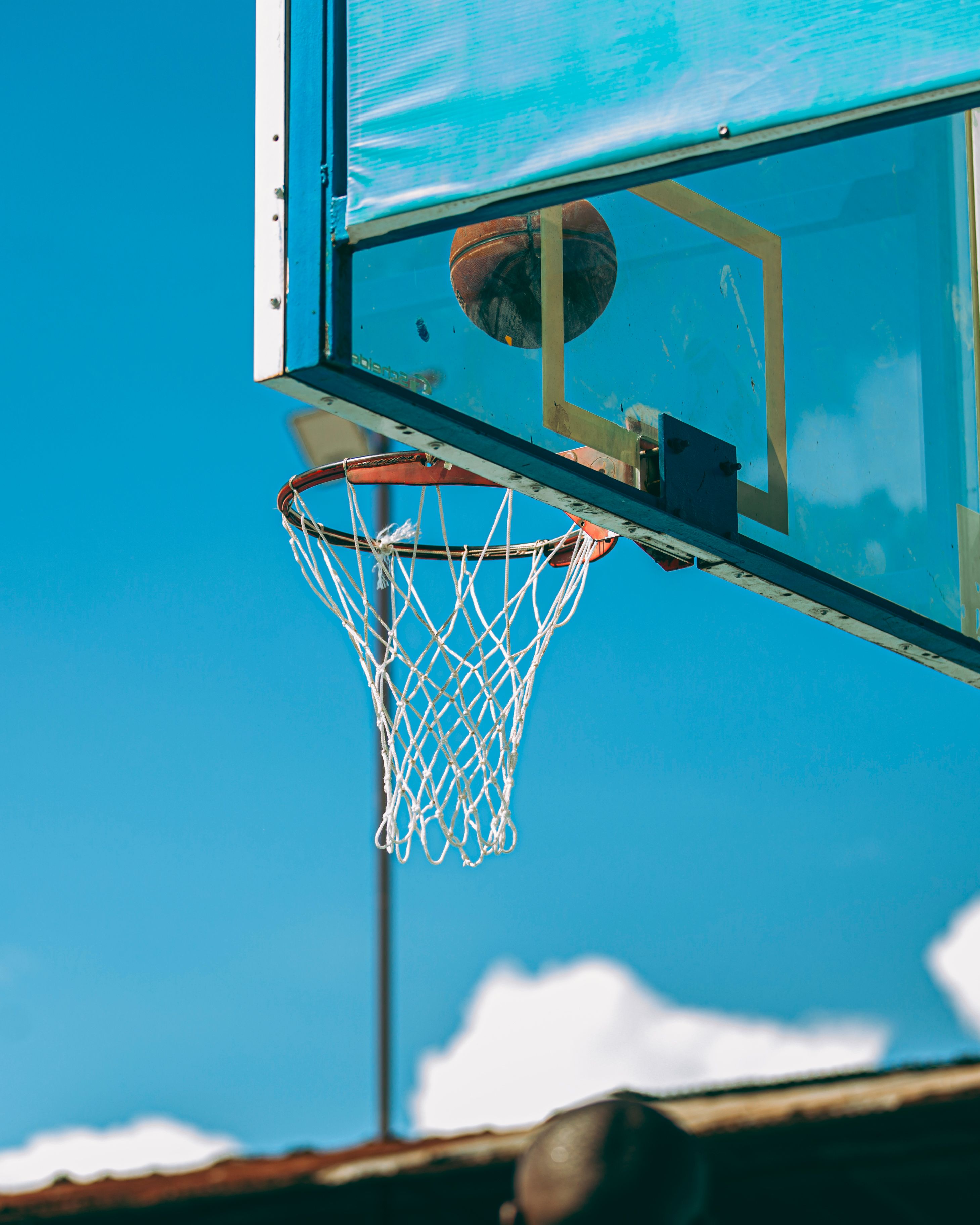 Outdoor Basketball Hoop with Ball in Mid-Air · Free Stock Photo