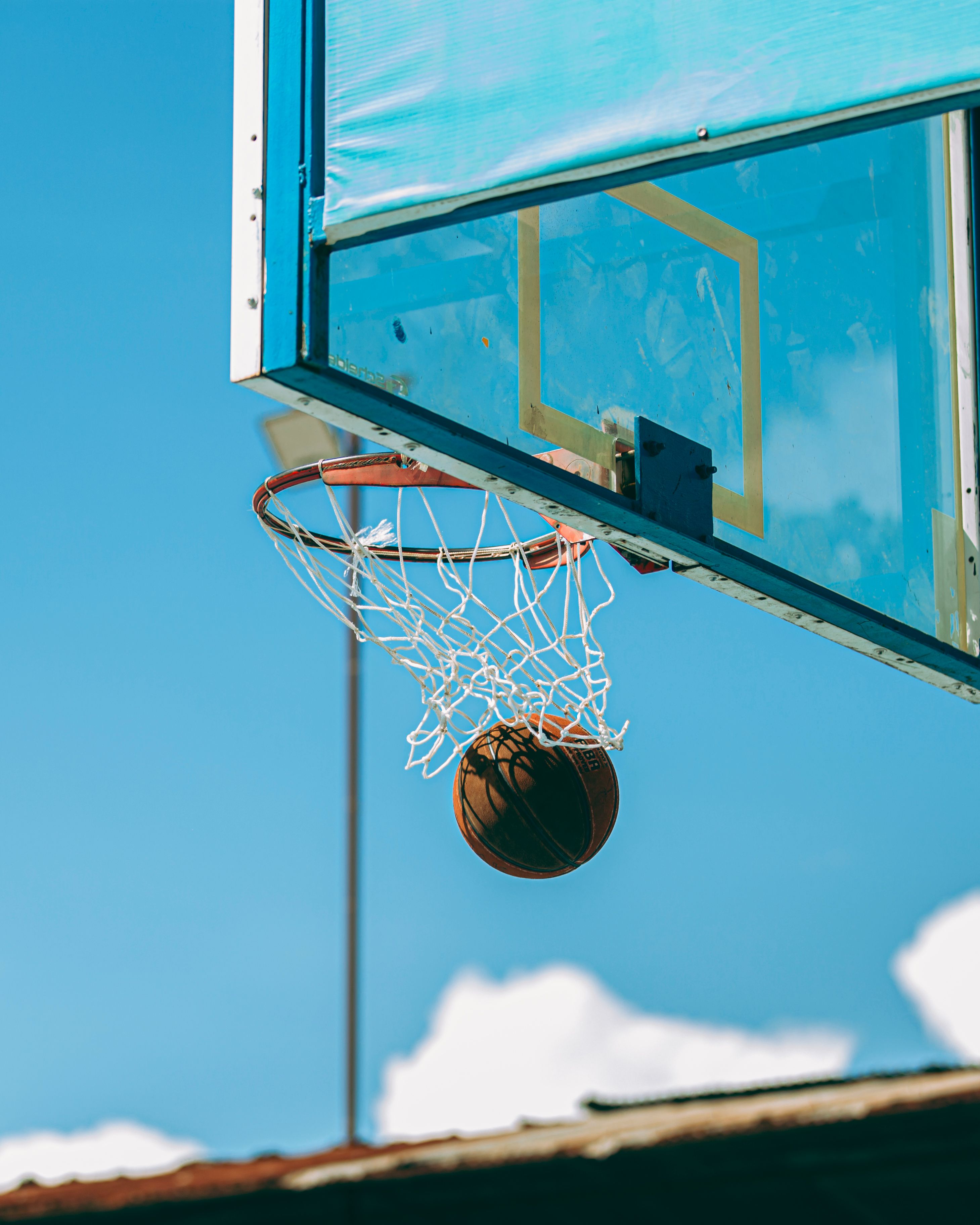Basketball Dunking into Hoop on Sunny Day · Free Stock Photo