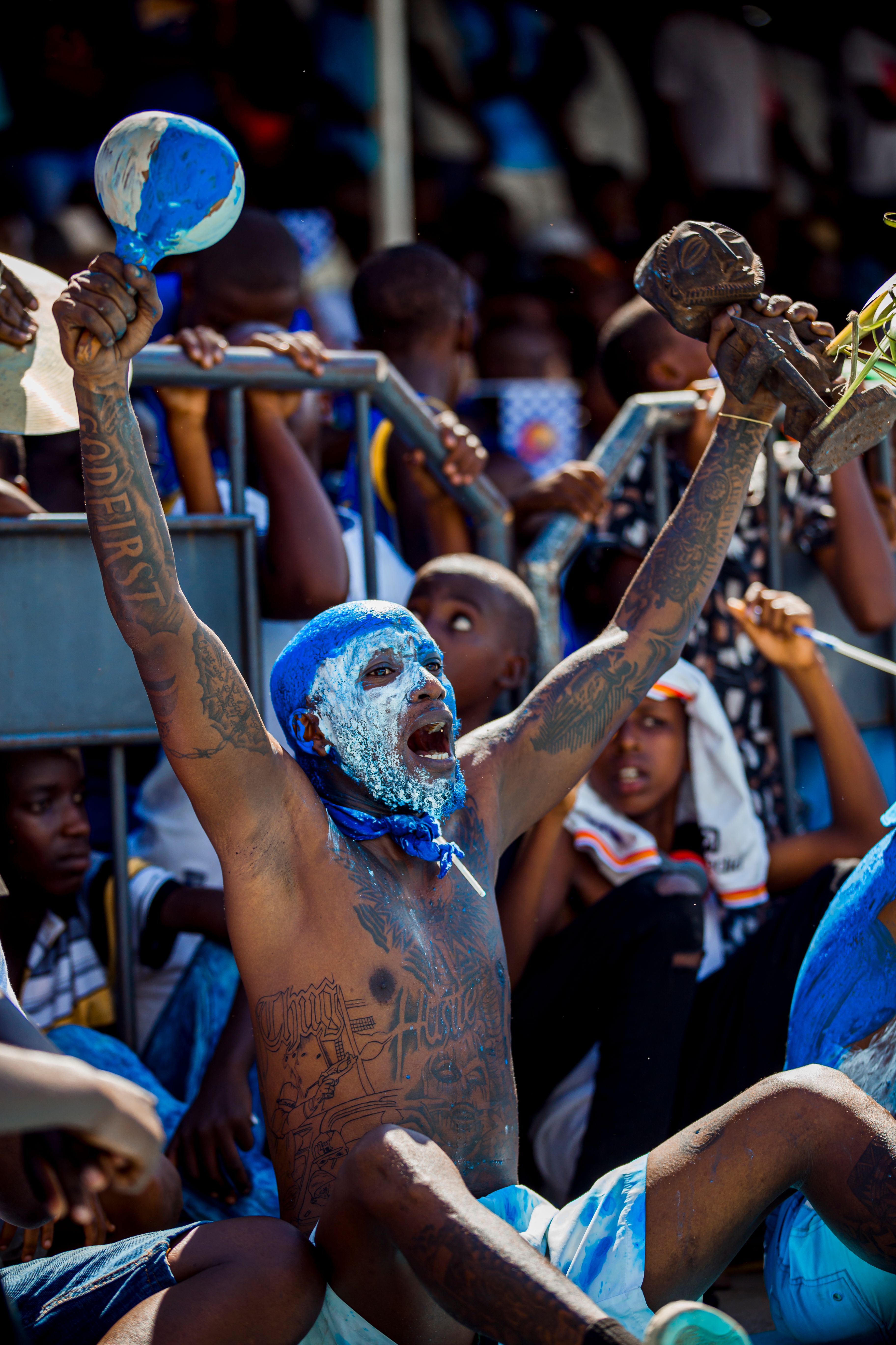 Celebratory Crowd with Festive Face Paint and Trophy · Free Stock Photo