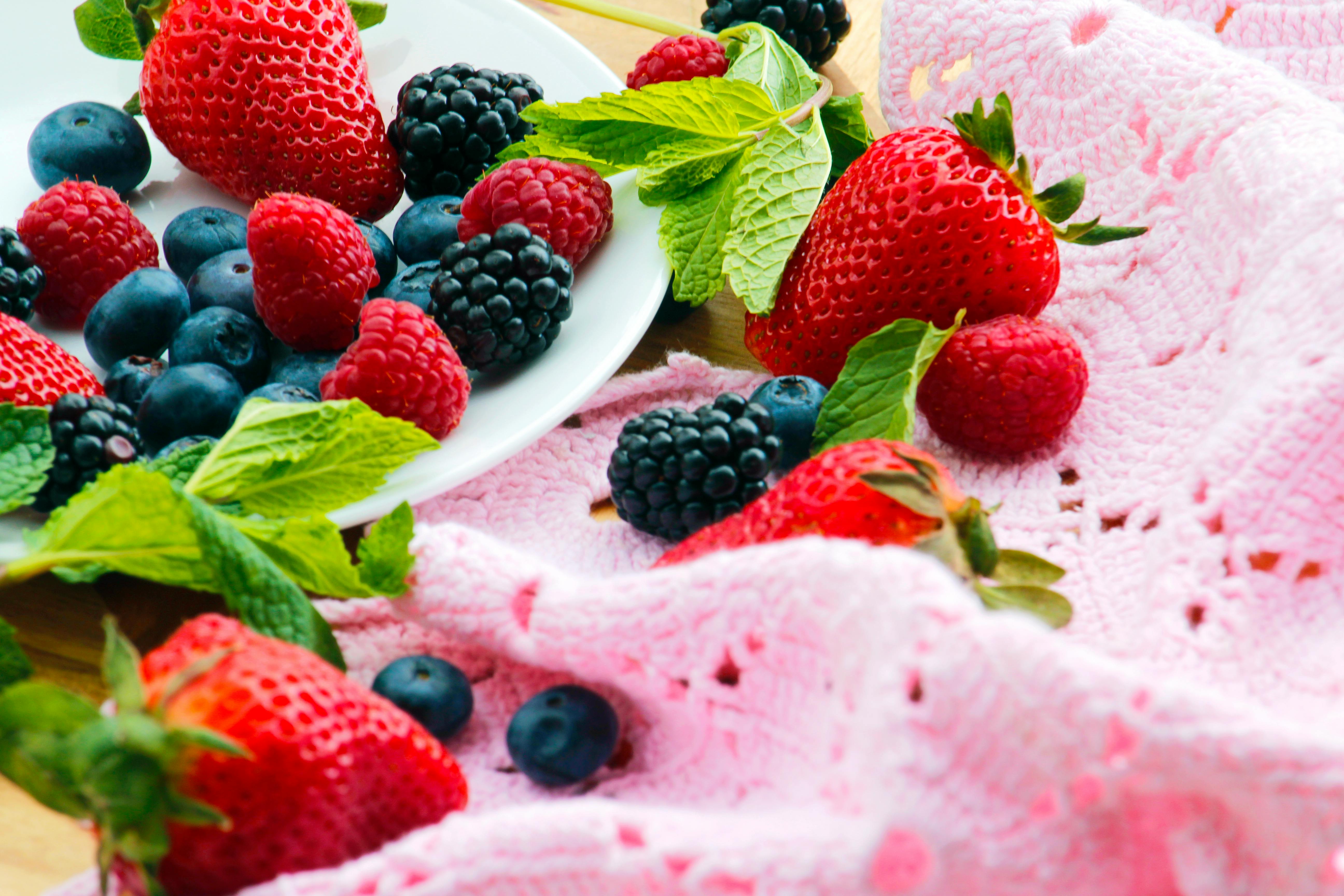 Fresh Mixed Berries on Pink Lace · Free Stock Photo