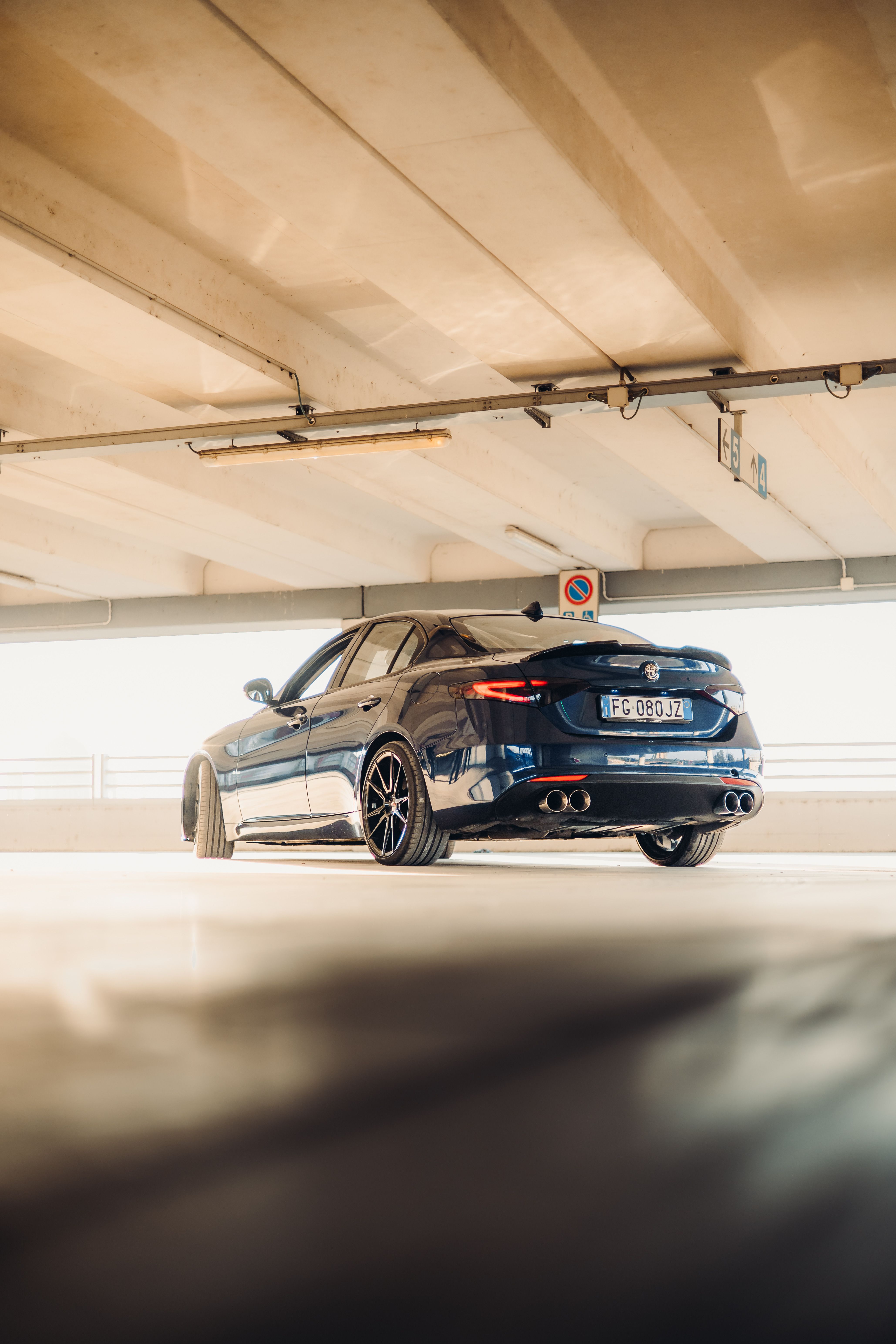 Sleek Blue Sports Car in Urban Garage Setting · Free Stock Photo