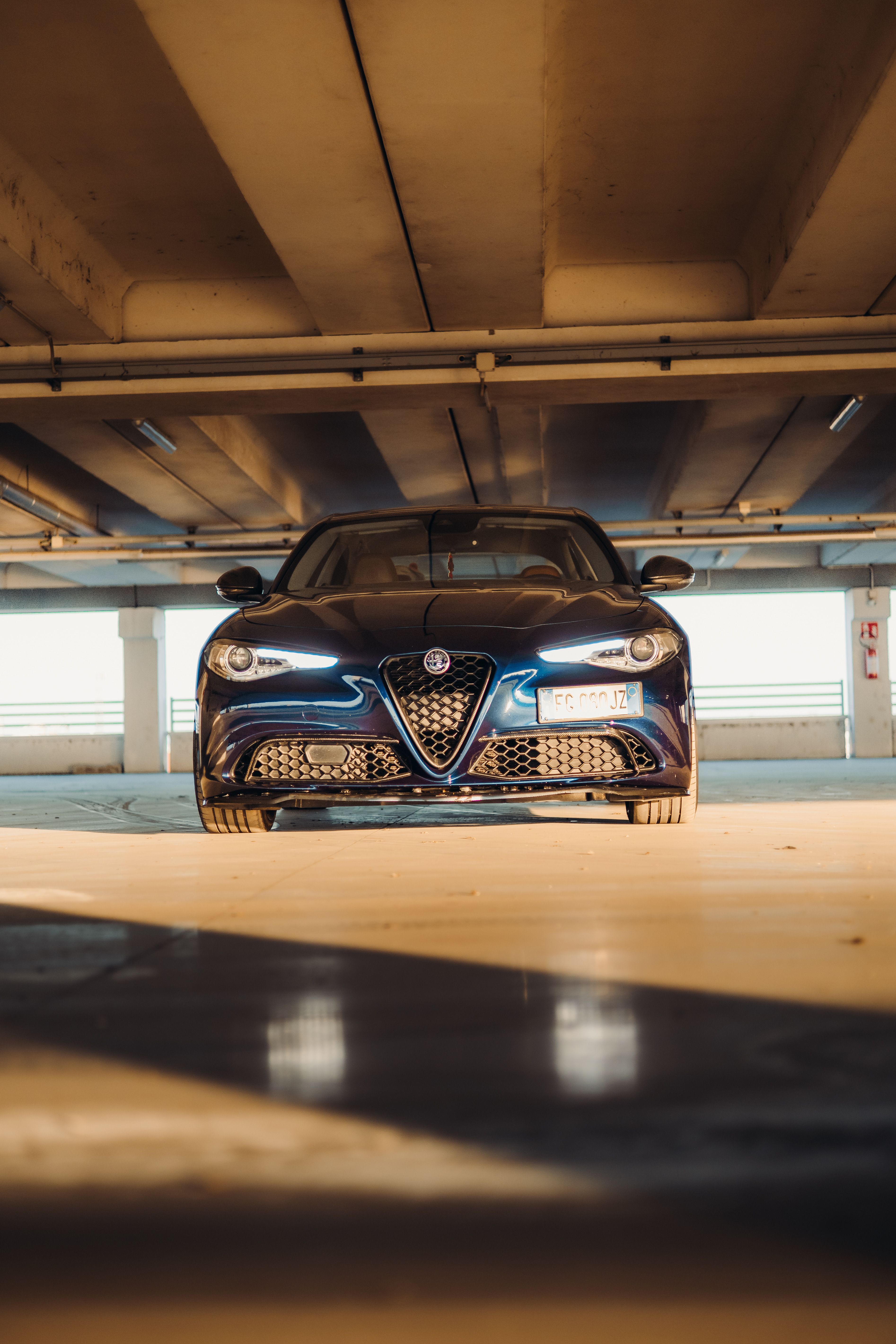 Sleek Blue Car in Urban Parking Garage · Free Stock Photo