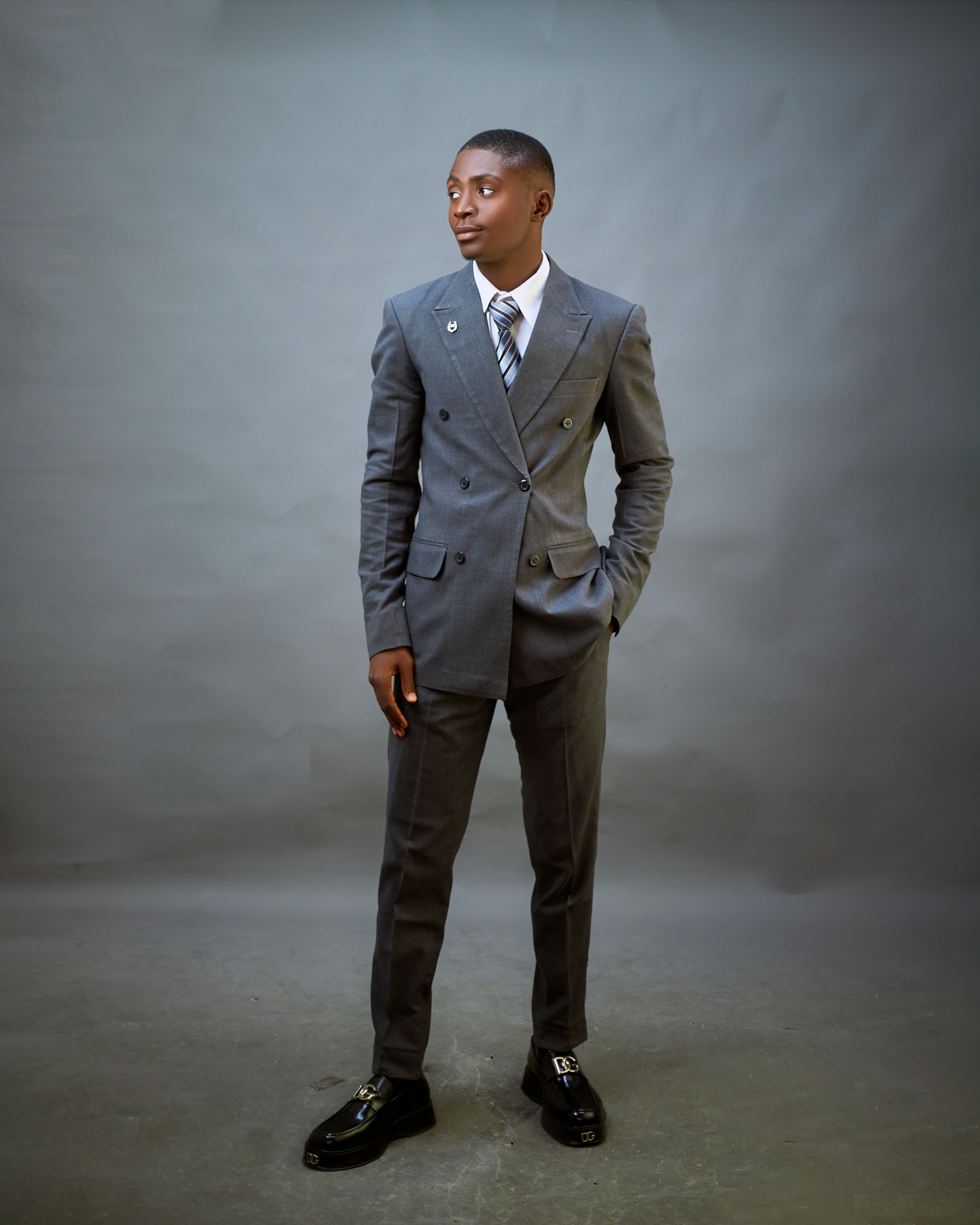 Stylish Man in Grey Suit Against Studio Background · Free Stock Photo