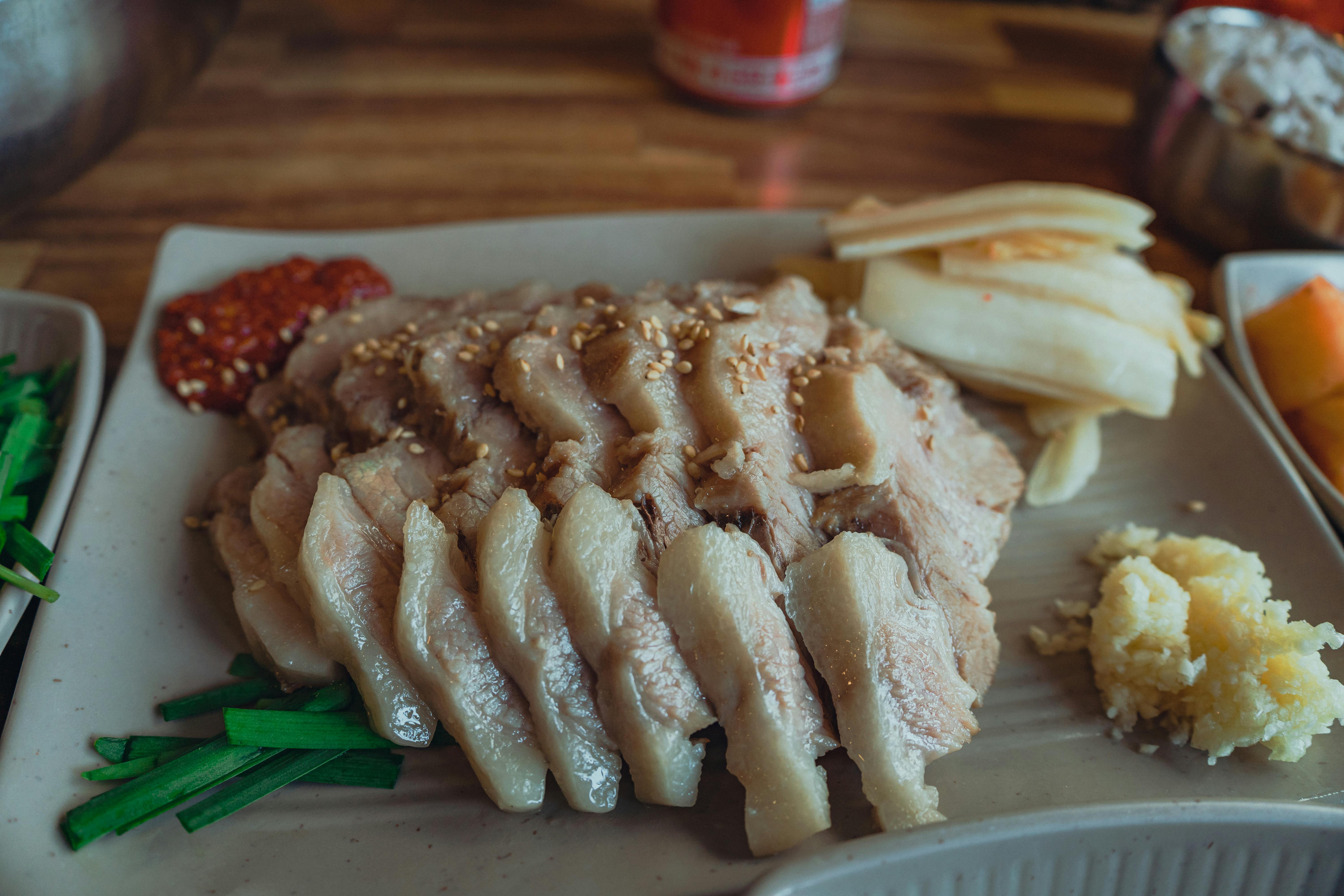 Traditional Korean Bossam with Kimchi and Garlic · Free Stock Photo