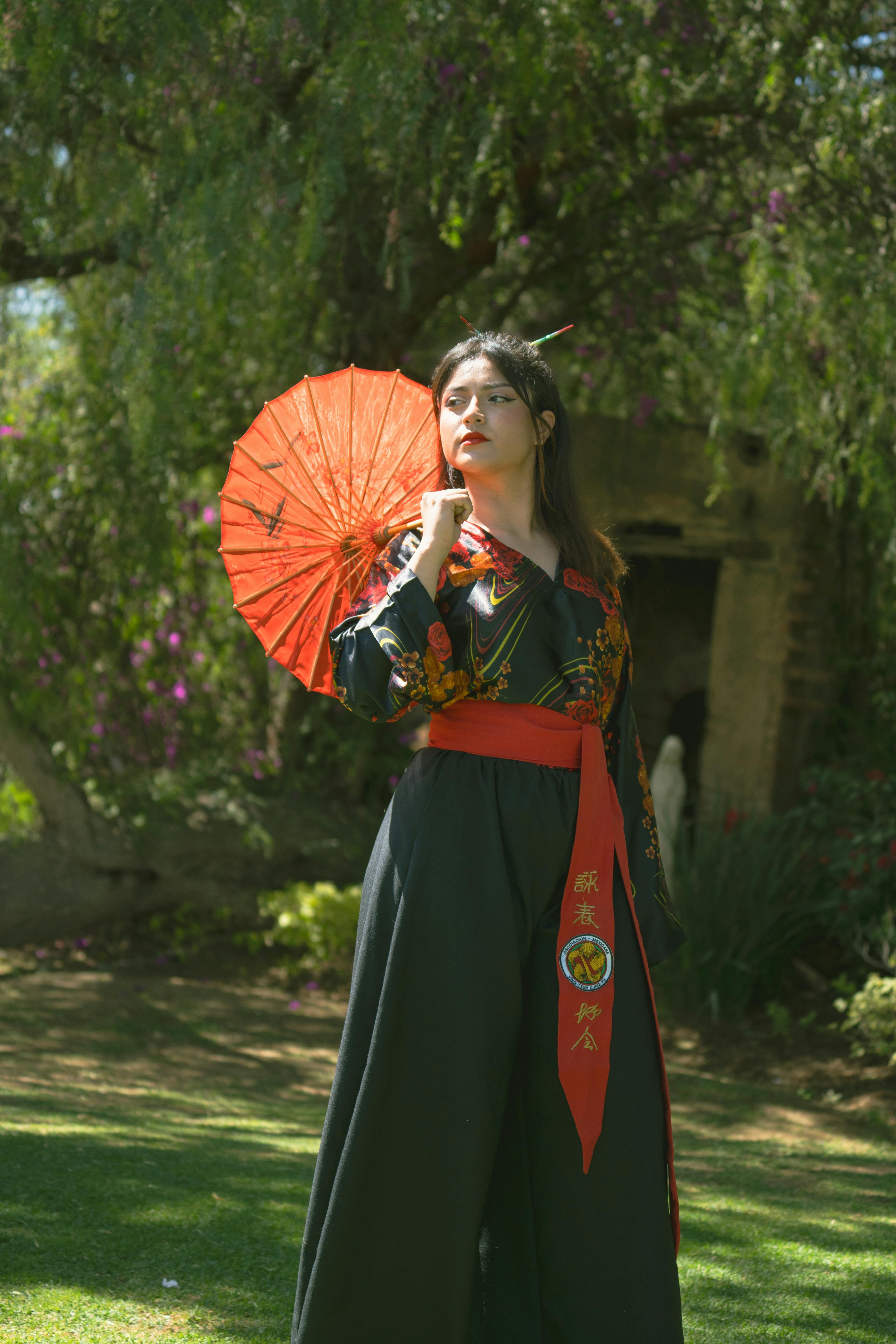 Woman in Kimono with Red Parasol in Garden · Free Stock Photo