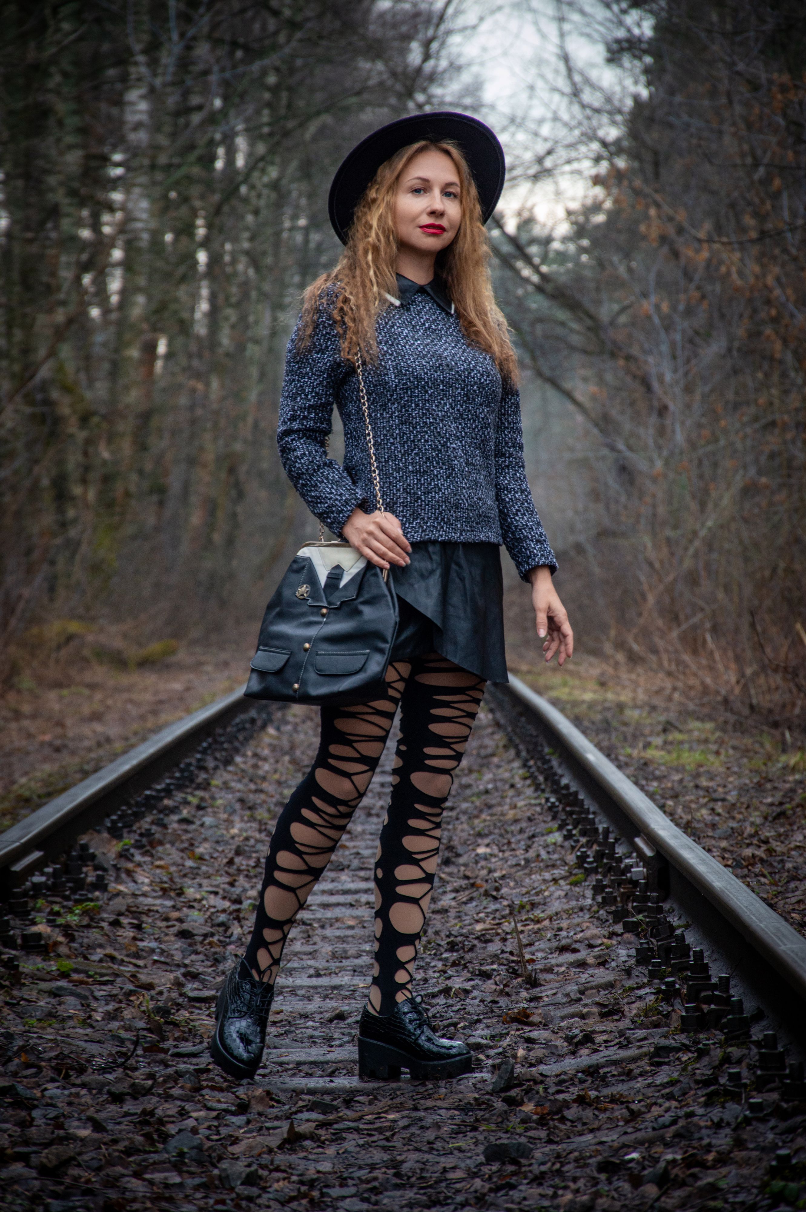 Fashionable woman posing on railway tracks outdoors · Free Stock Photo