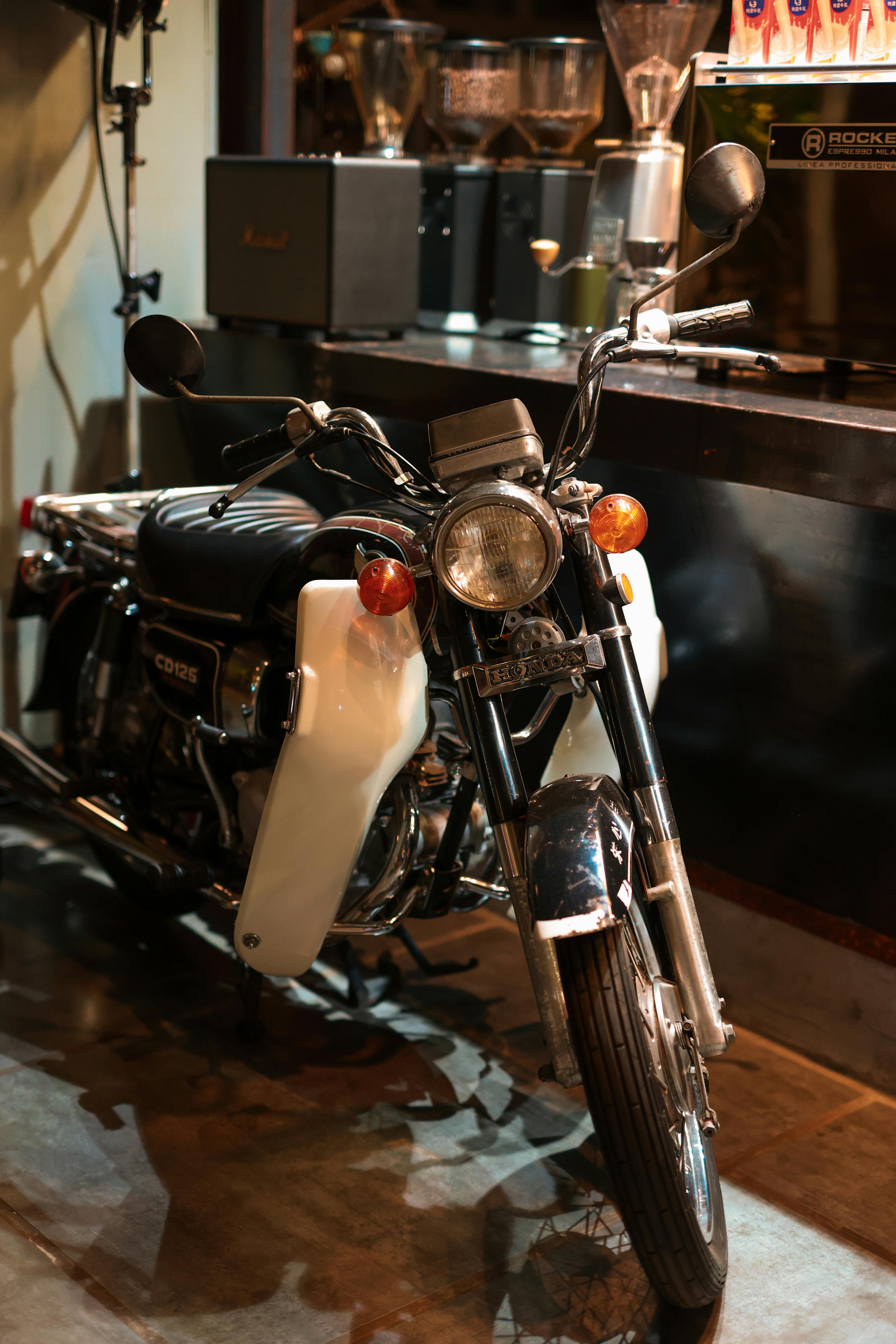 Classic Motorcycle in Vietnamese Cafe Setting · Free Stock Photo