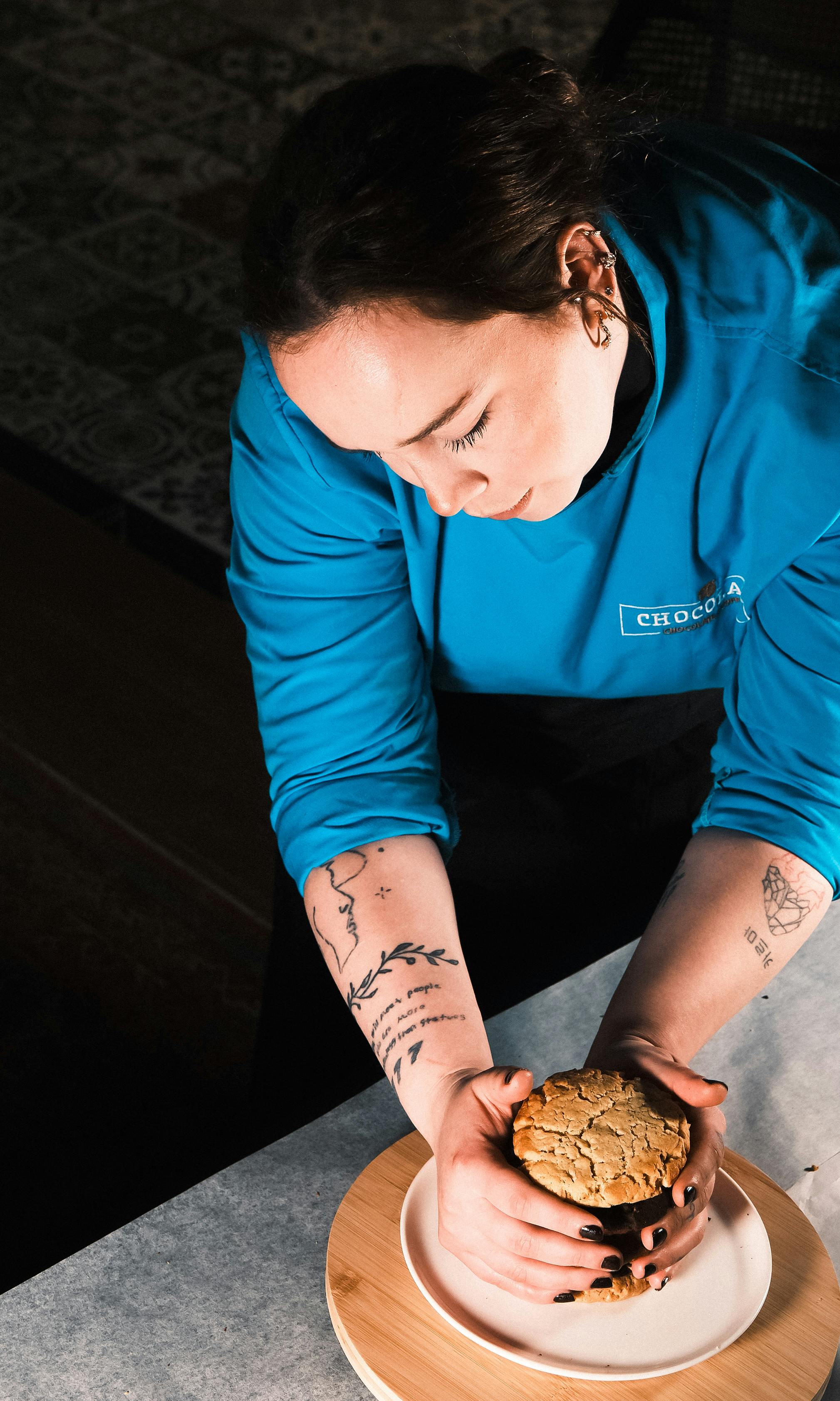 Chef plating a freshly baked cookie in a kitchen · Free Stock Photo
