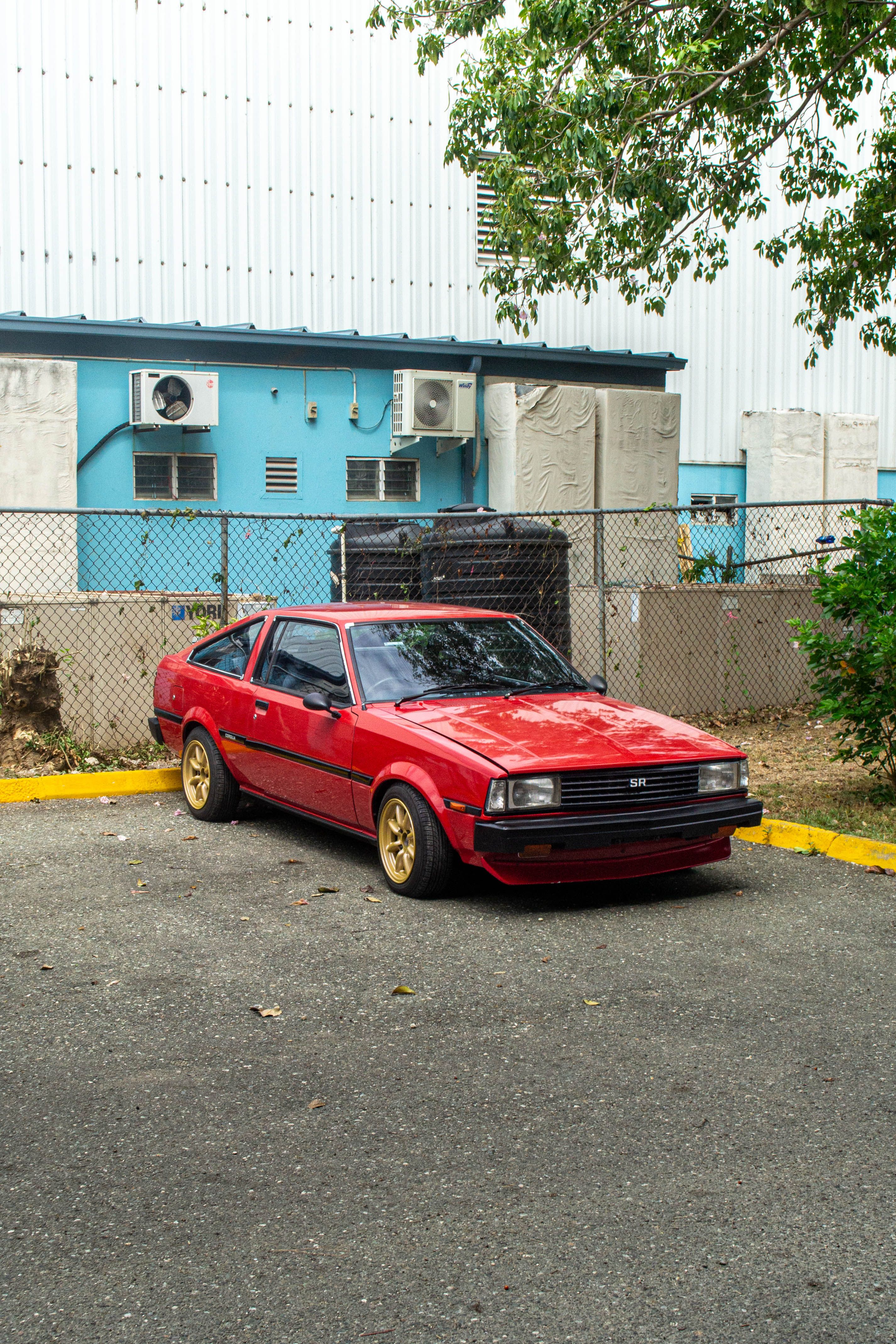 Vintage Red Toyota Car in Urban Setting · Free Stock Photo