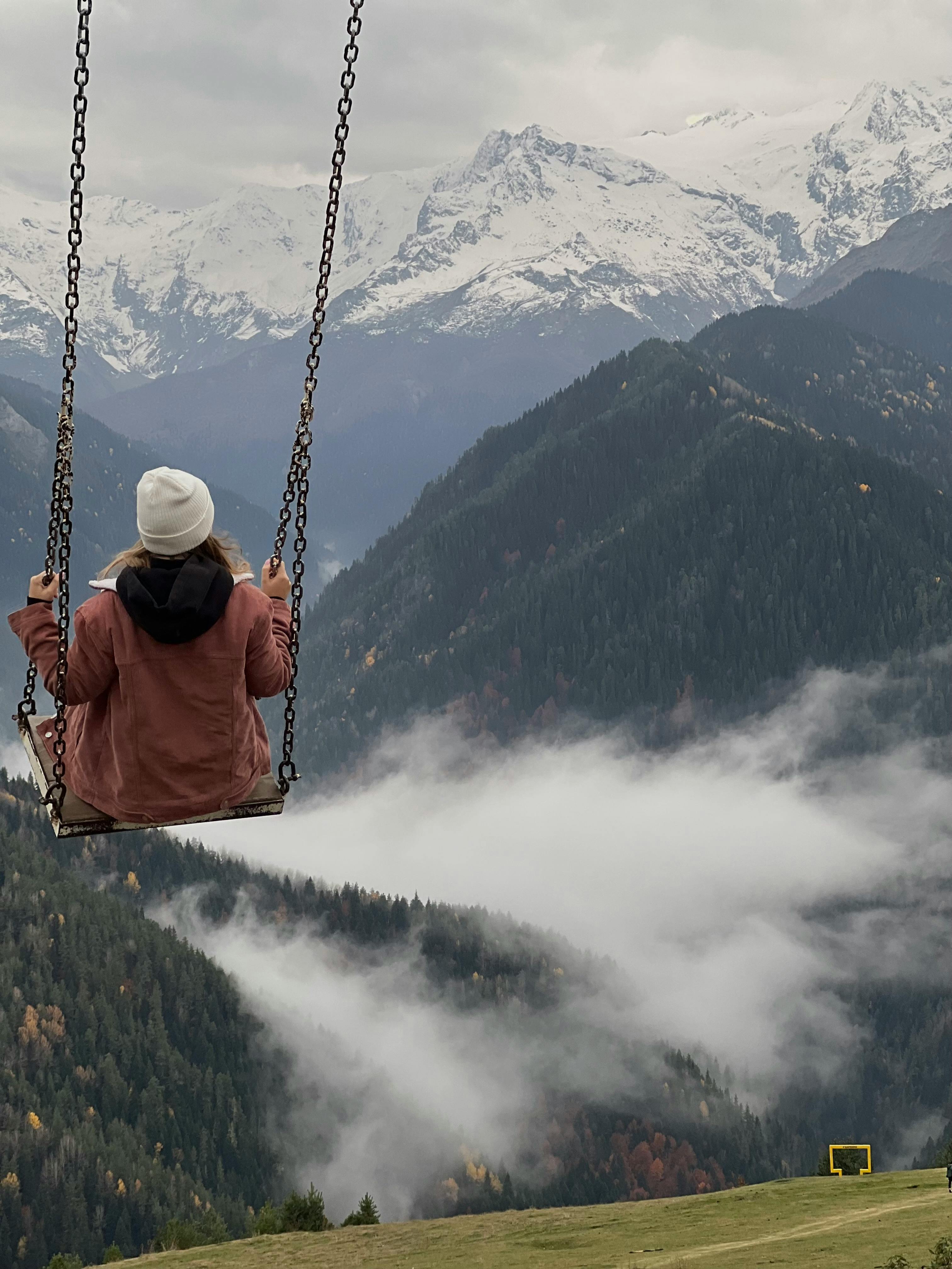 Scenic Mountain Swing Overlooking Snowy Peaks · Free Stock Photo