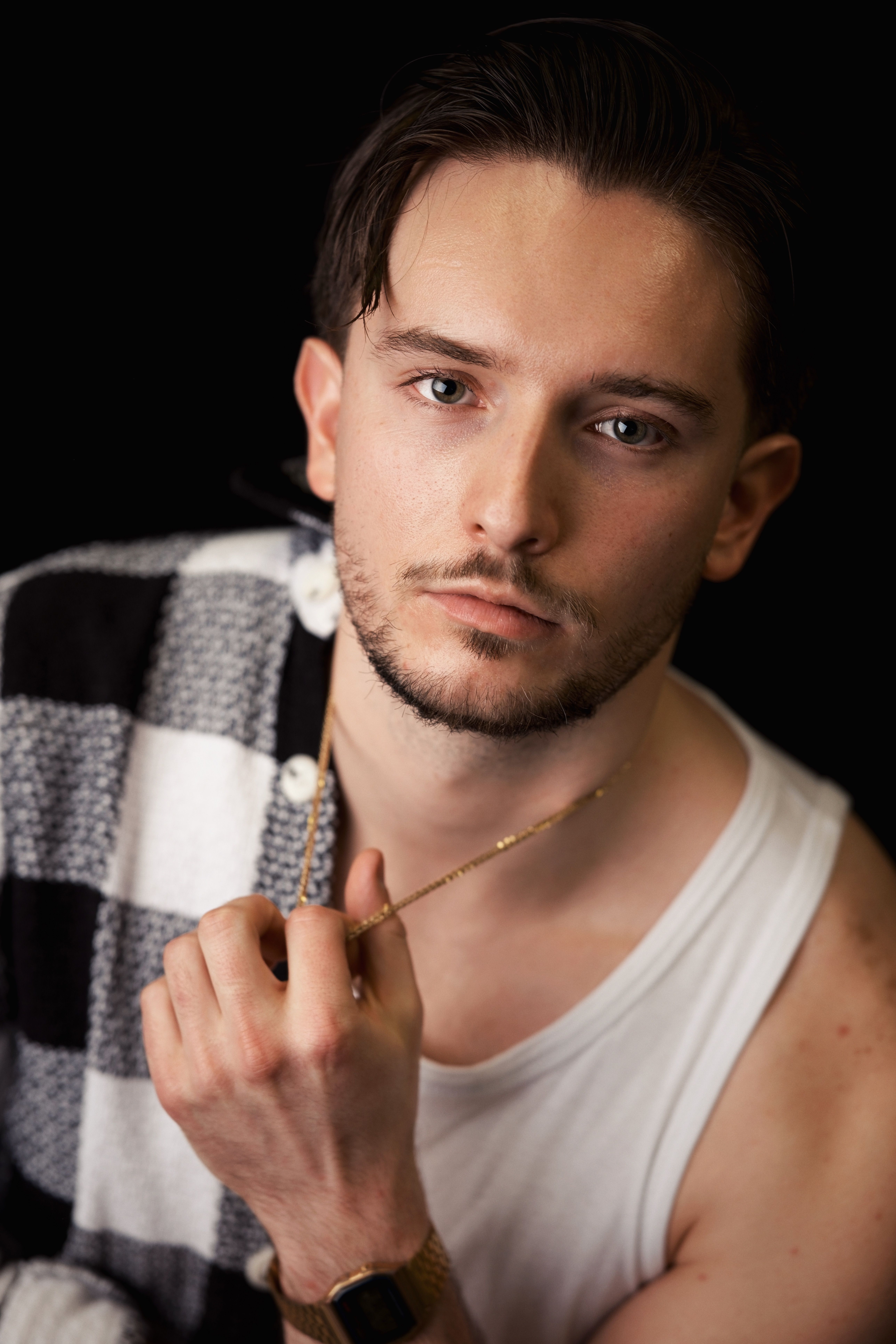 Stylish Young Man in Checkerboard Sweater Portrait · Free Stock Photo