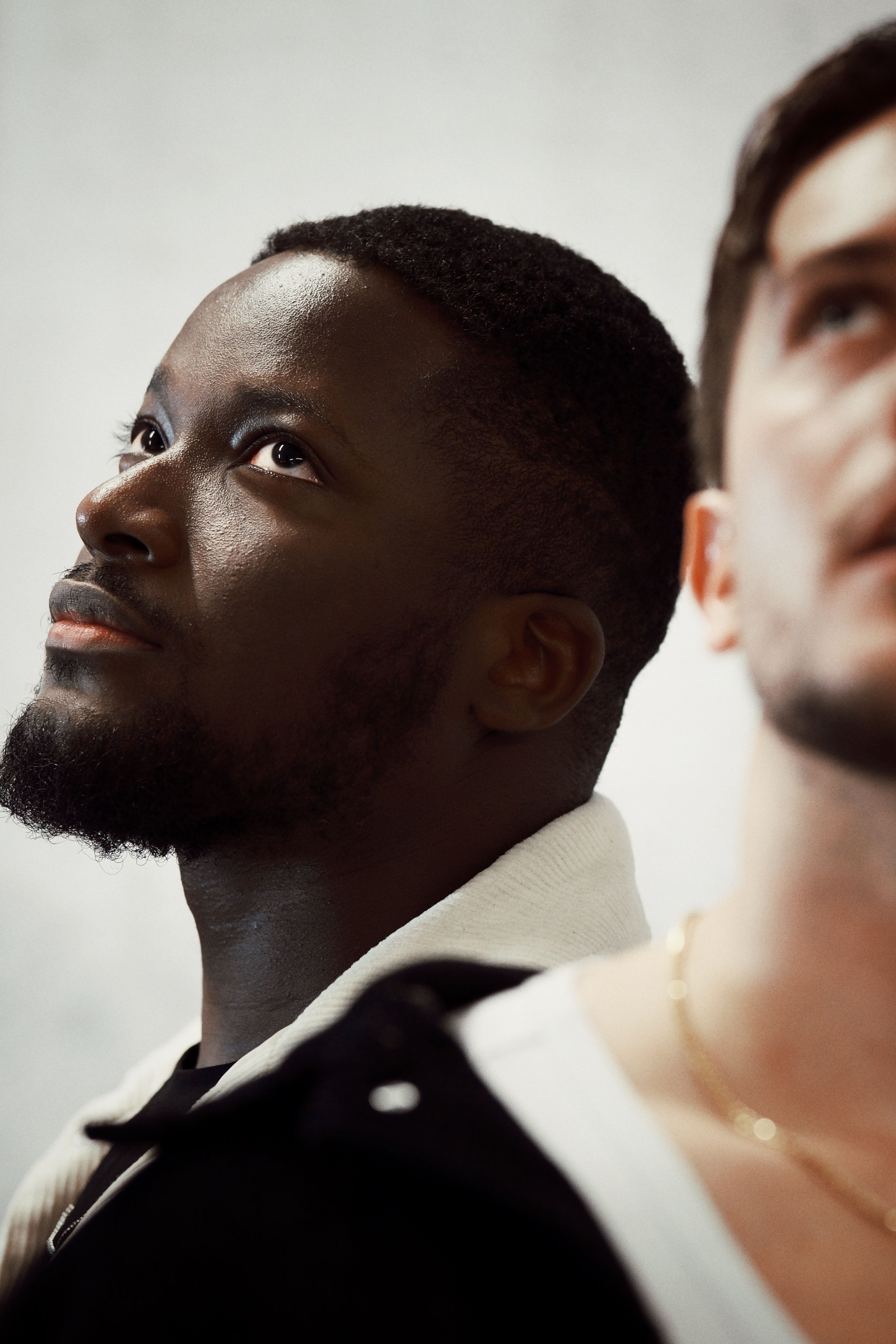 Close-up of Two Men Looking Upward · Free Stock Photo