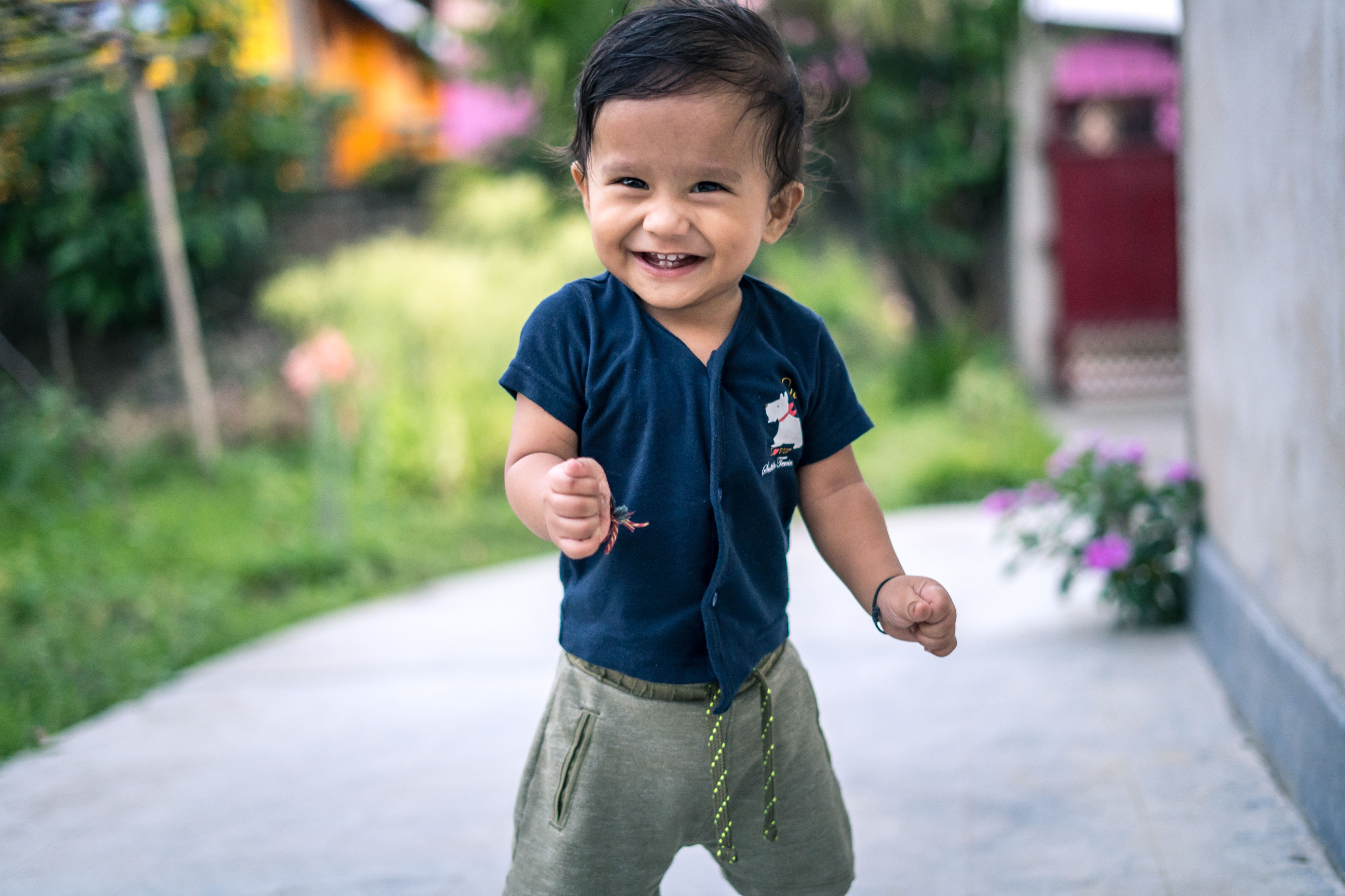 Joyful Toddler Smiling in Outdoor Setting · Free Stock Photo