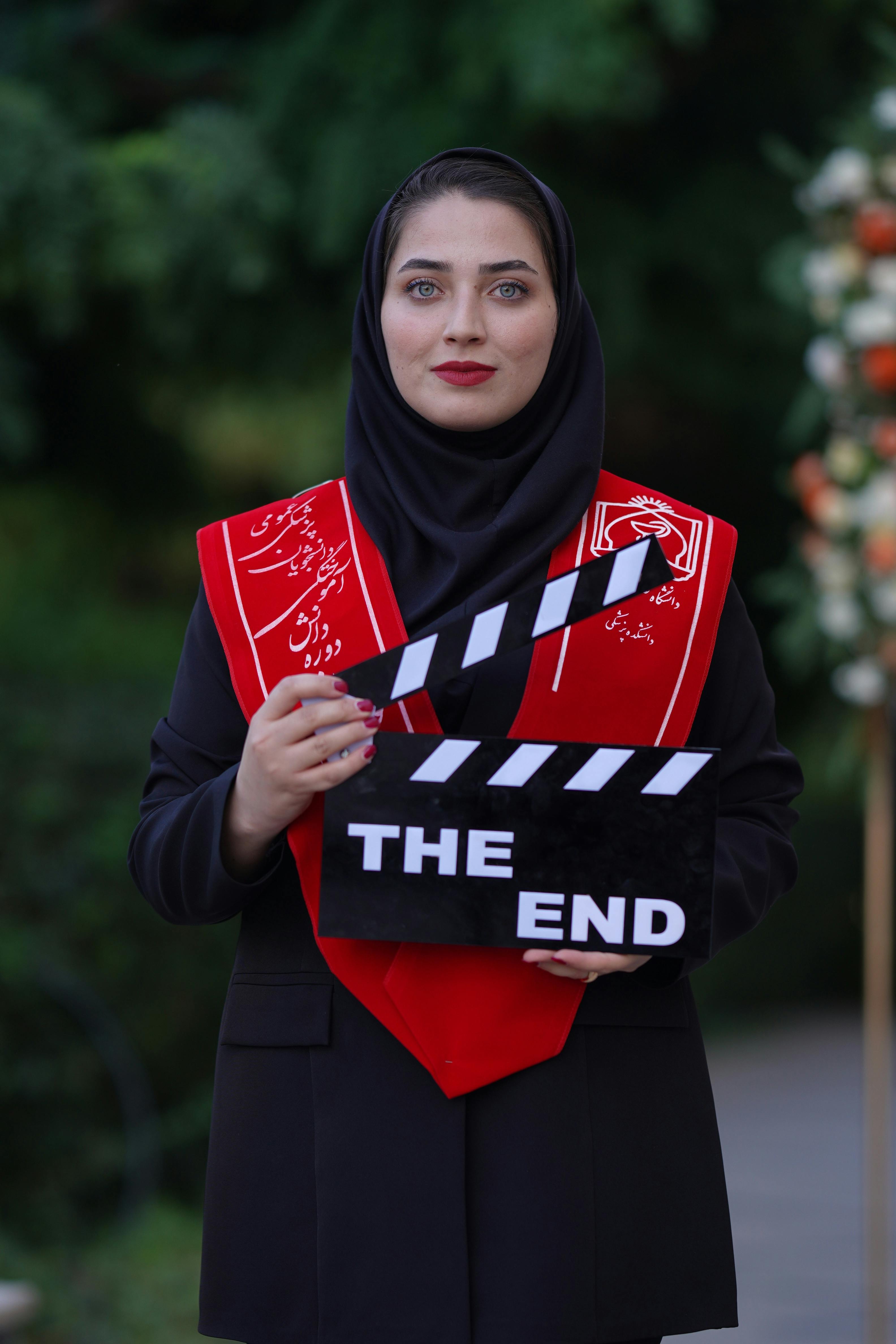 Iranian Graduation Ceremony with Clapperboard · Free Stock Photo