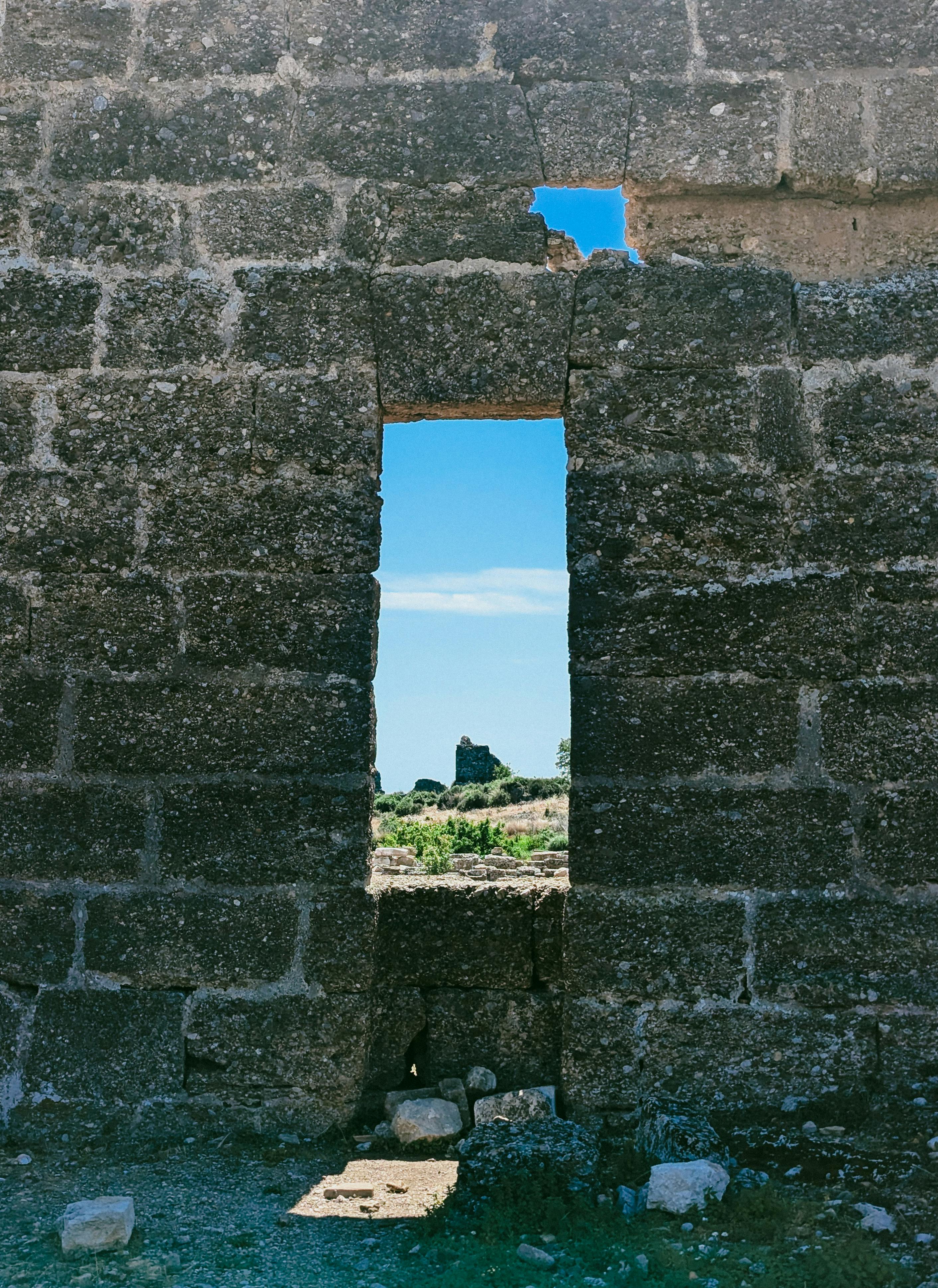 Ancient Stone Window Framing Scenic Ruins View · Free Stock Photo