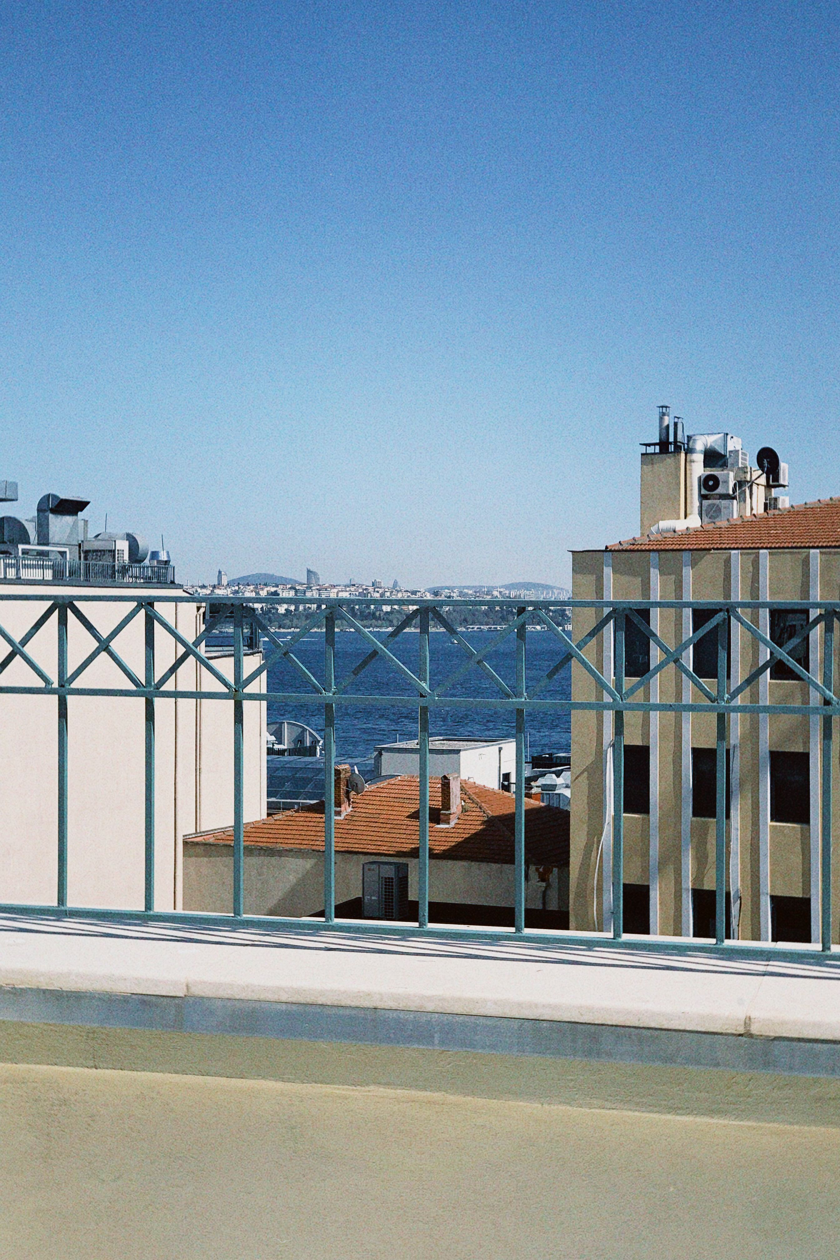 Scenic City Rooftop View with Sea Background · Free Stock Photo