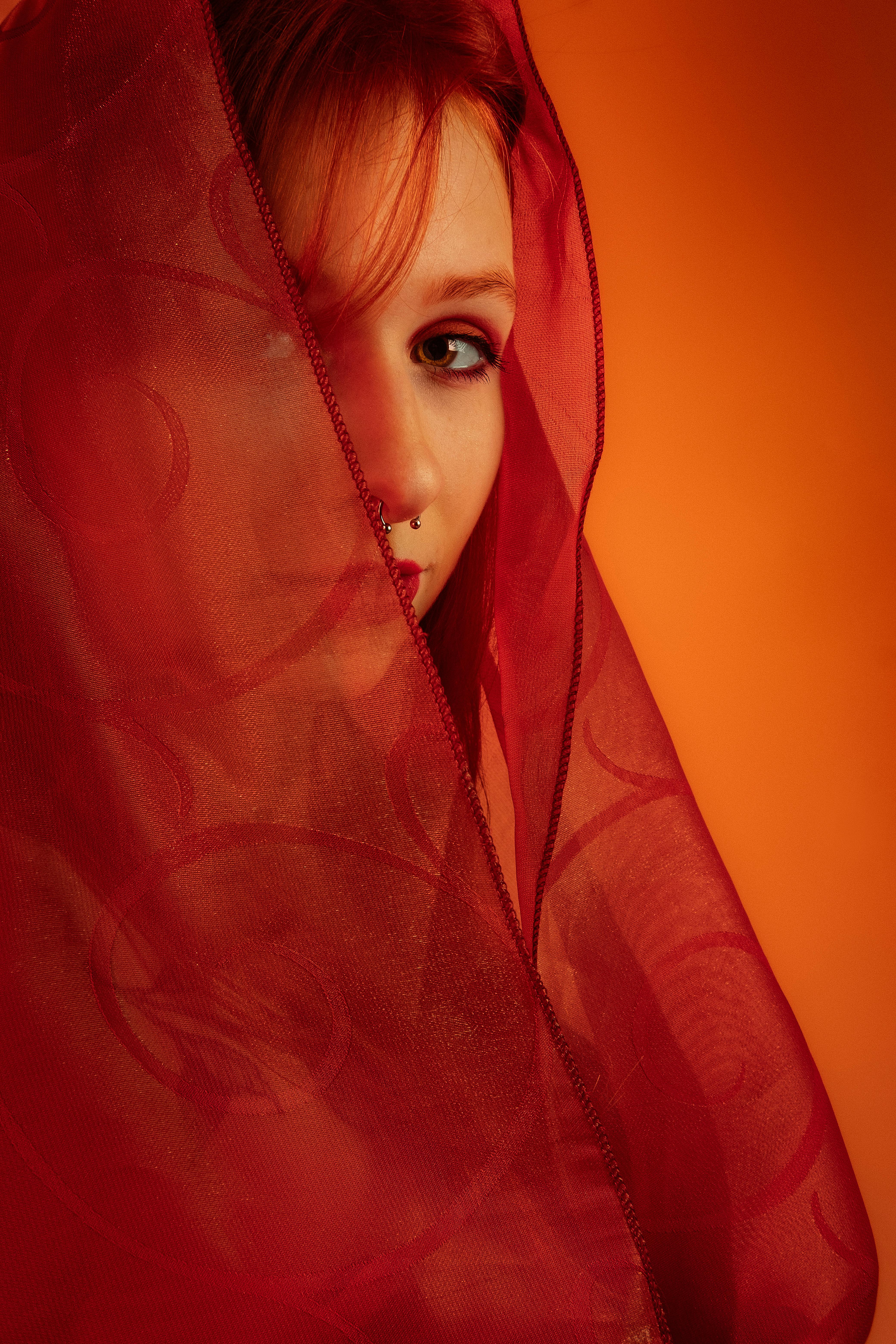 Enigmatic Portrait with Red Sheer Fabric · Free Stock Photo
