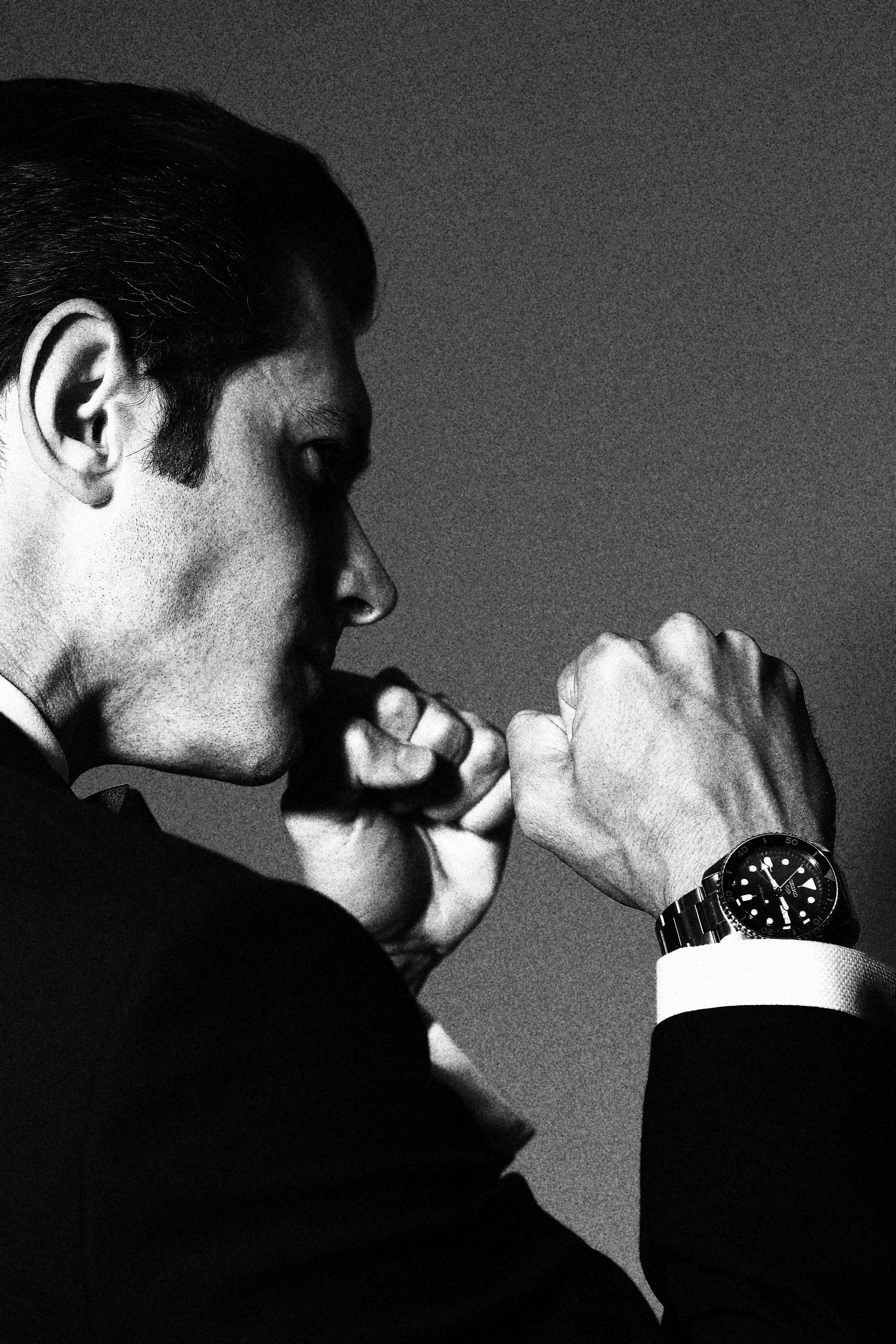 Stylish Man Showcasing Luxury Watch in Profile · Free Stock Photo