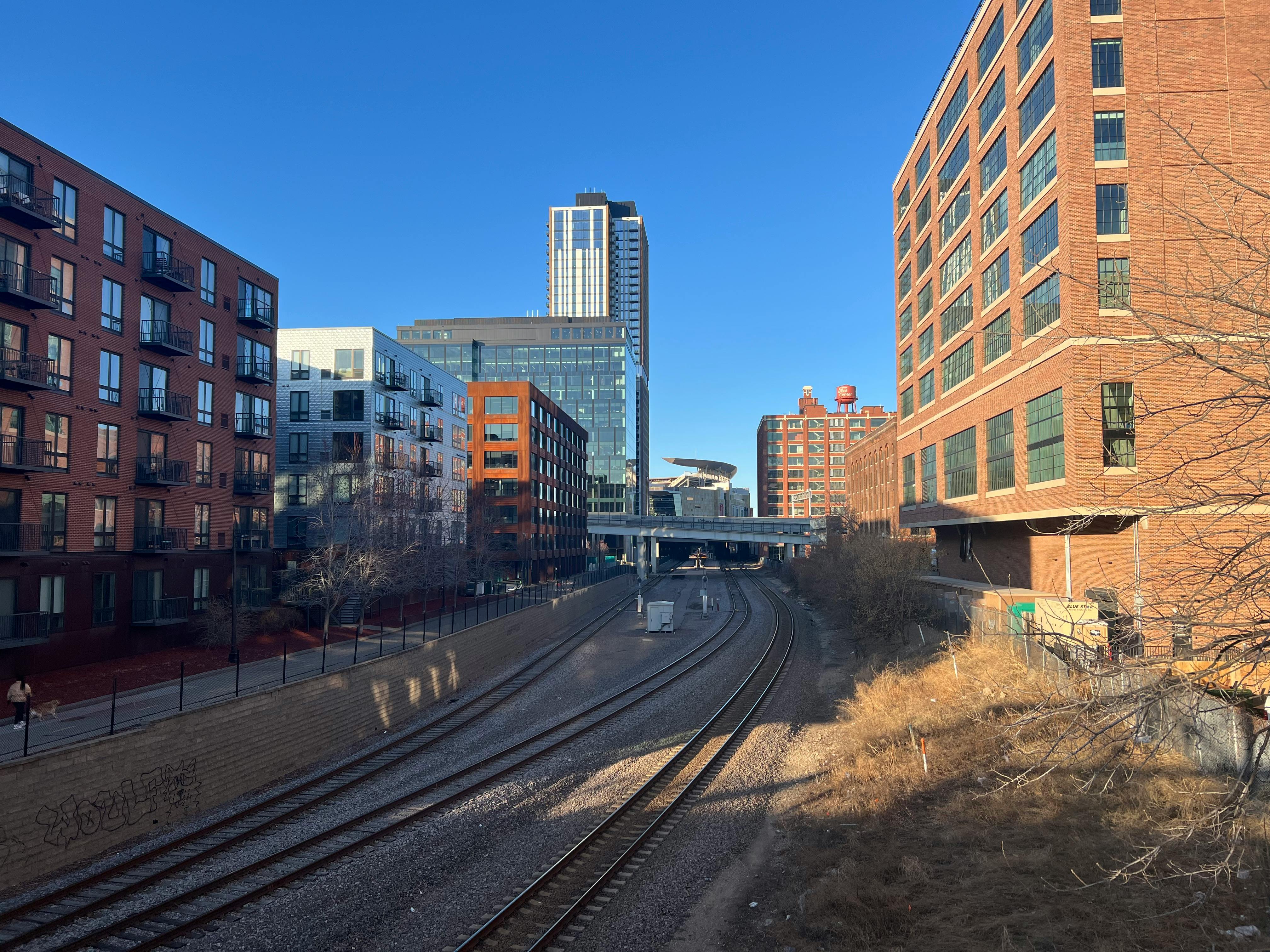 Urban Train Tracks Amidst Cityscape Architecture · Free Stock Photo
