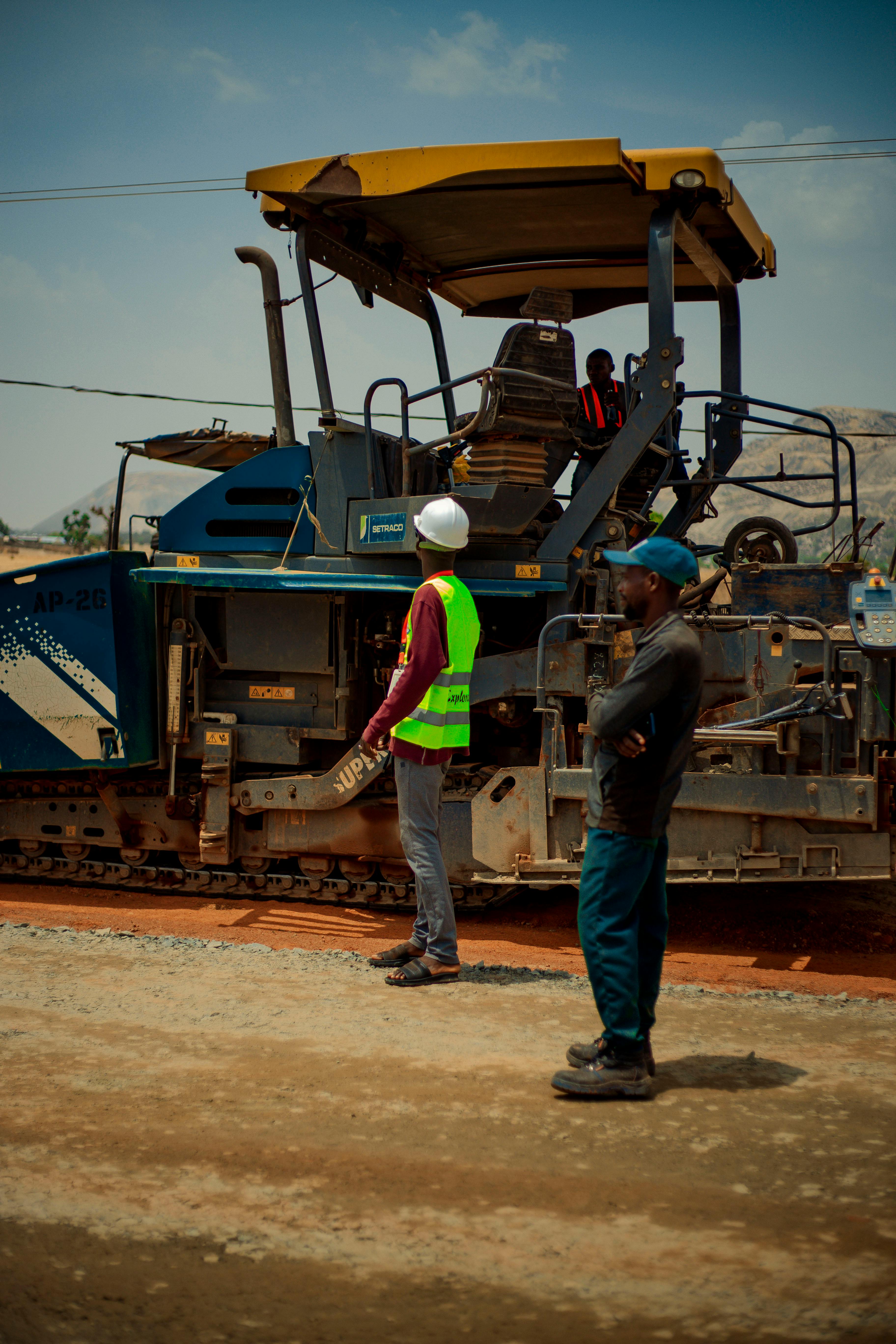 Two People Walking on a Construction Site · Free Stock Photo