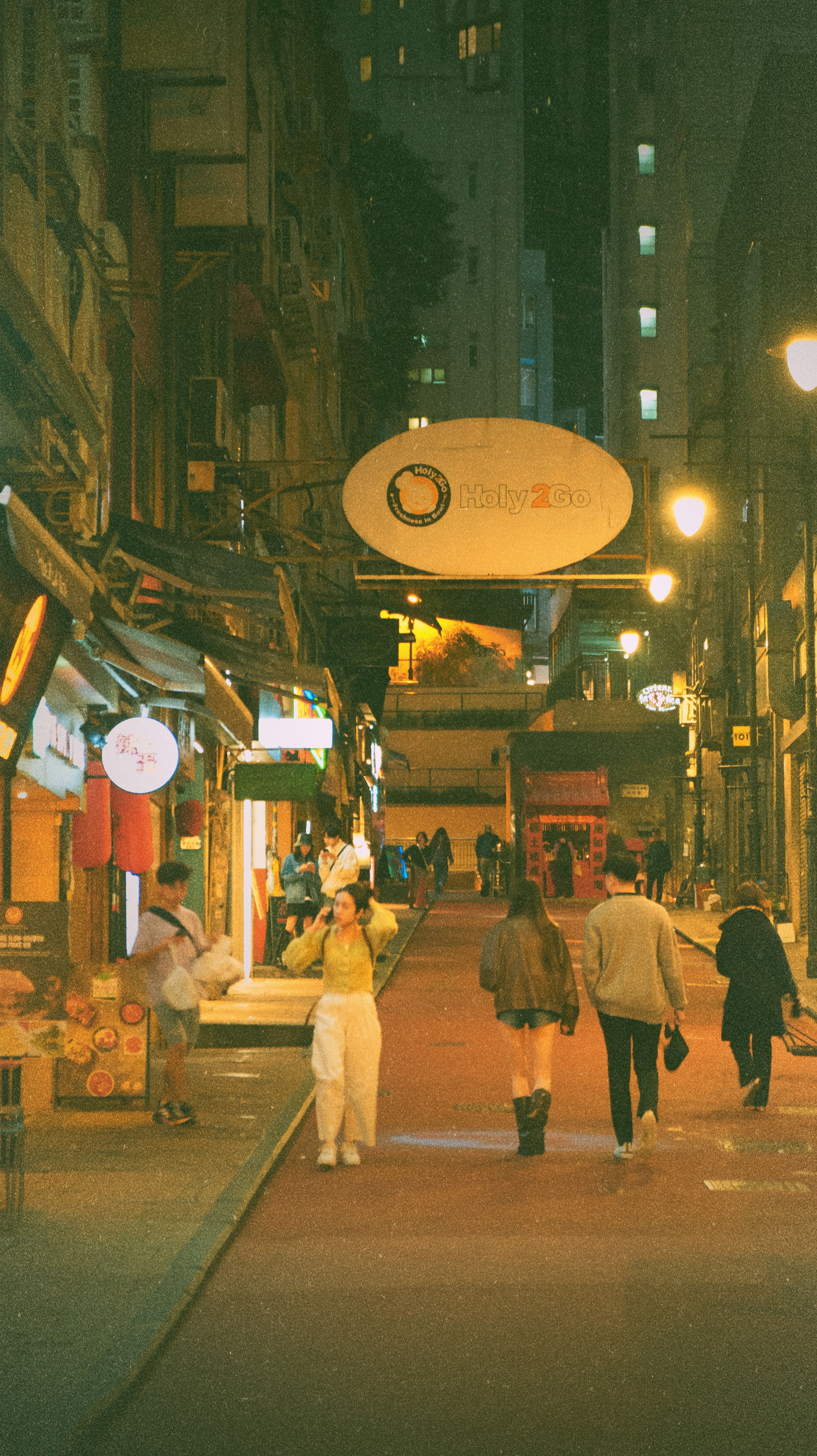 Urban Night Scene with Streetlights and Pedestrians · Free Stock Photo