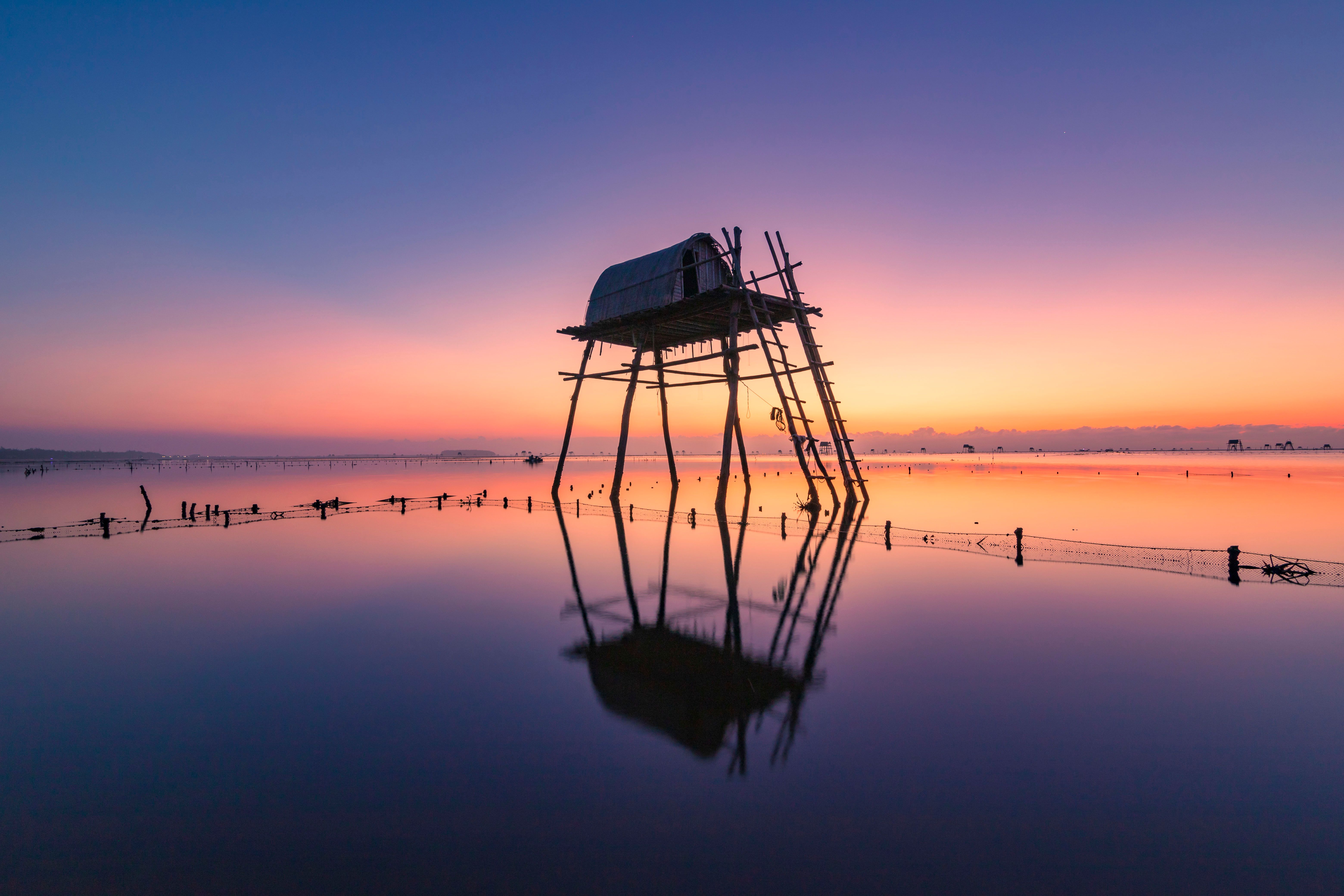 Scenic Vietnamese Hut Over Water at Sunset · Free Stock Photo