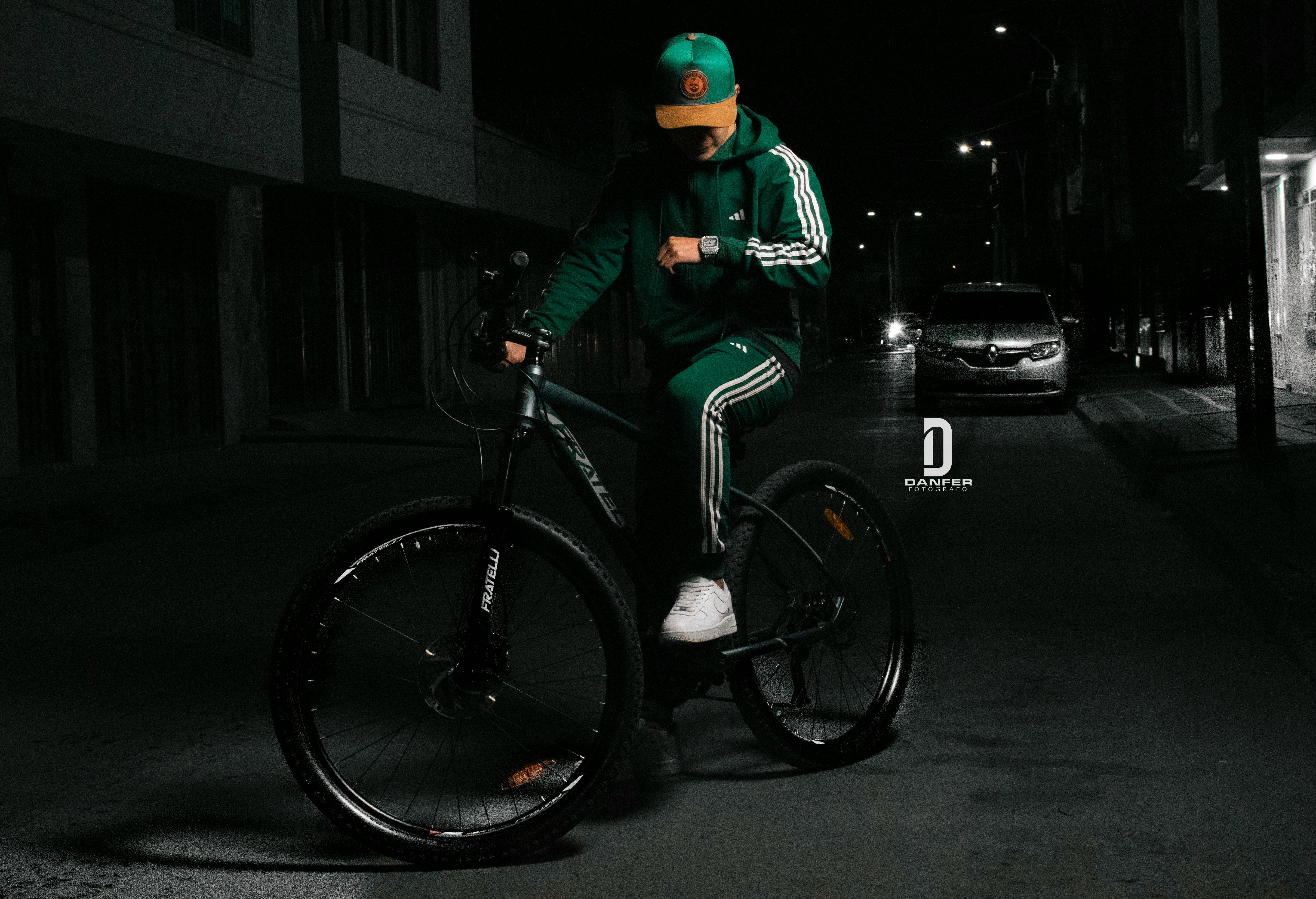 Night Biker in Bogotá with Green Tracksuit · Free Stock Photo
