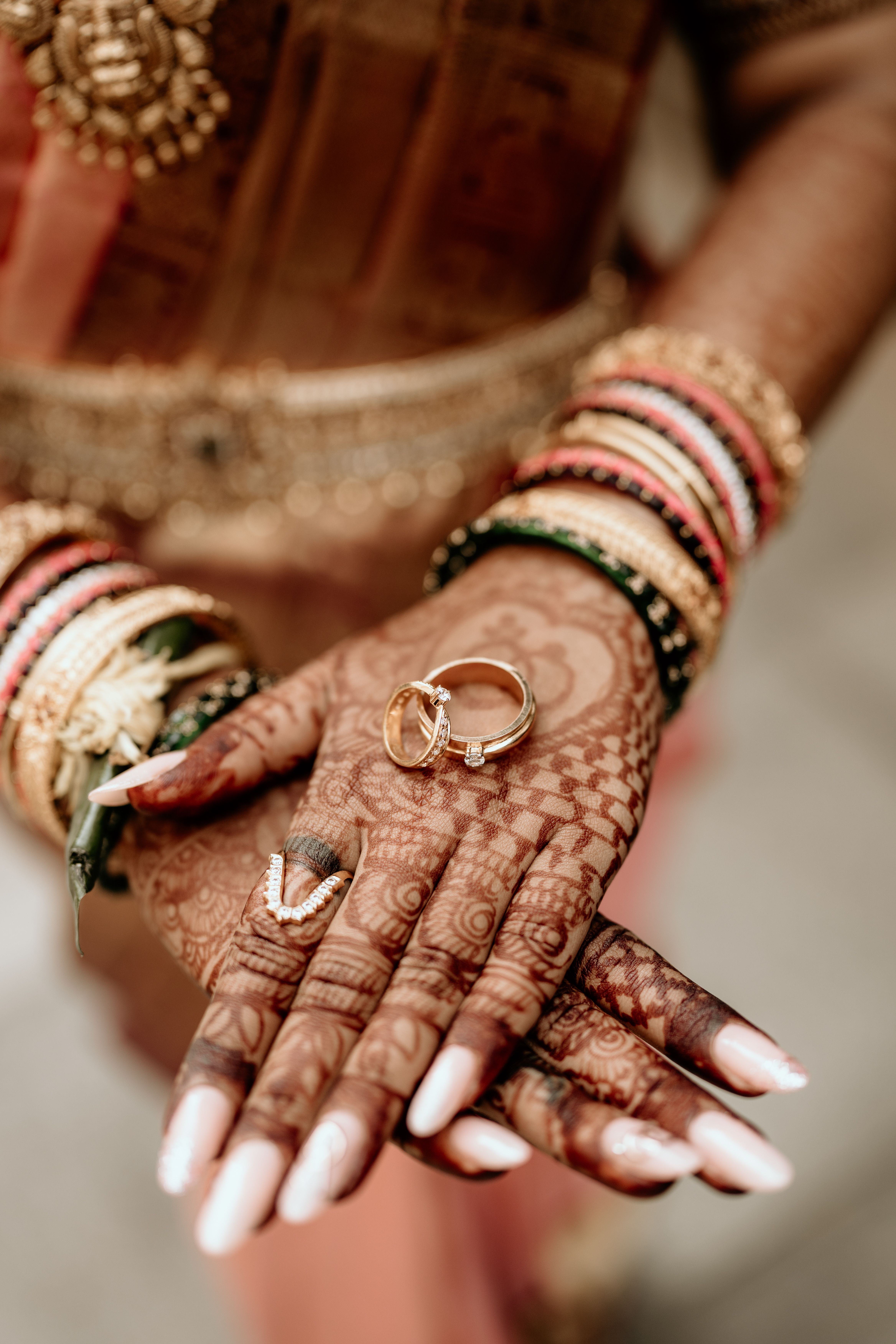 Elegant Henna Bridal Hands Holding Wedding Rings · Free Stock Photo