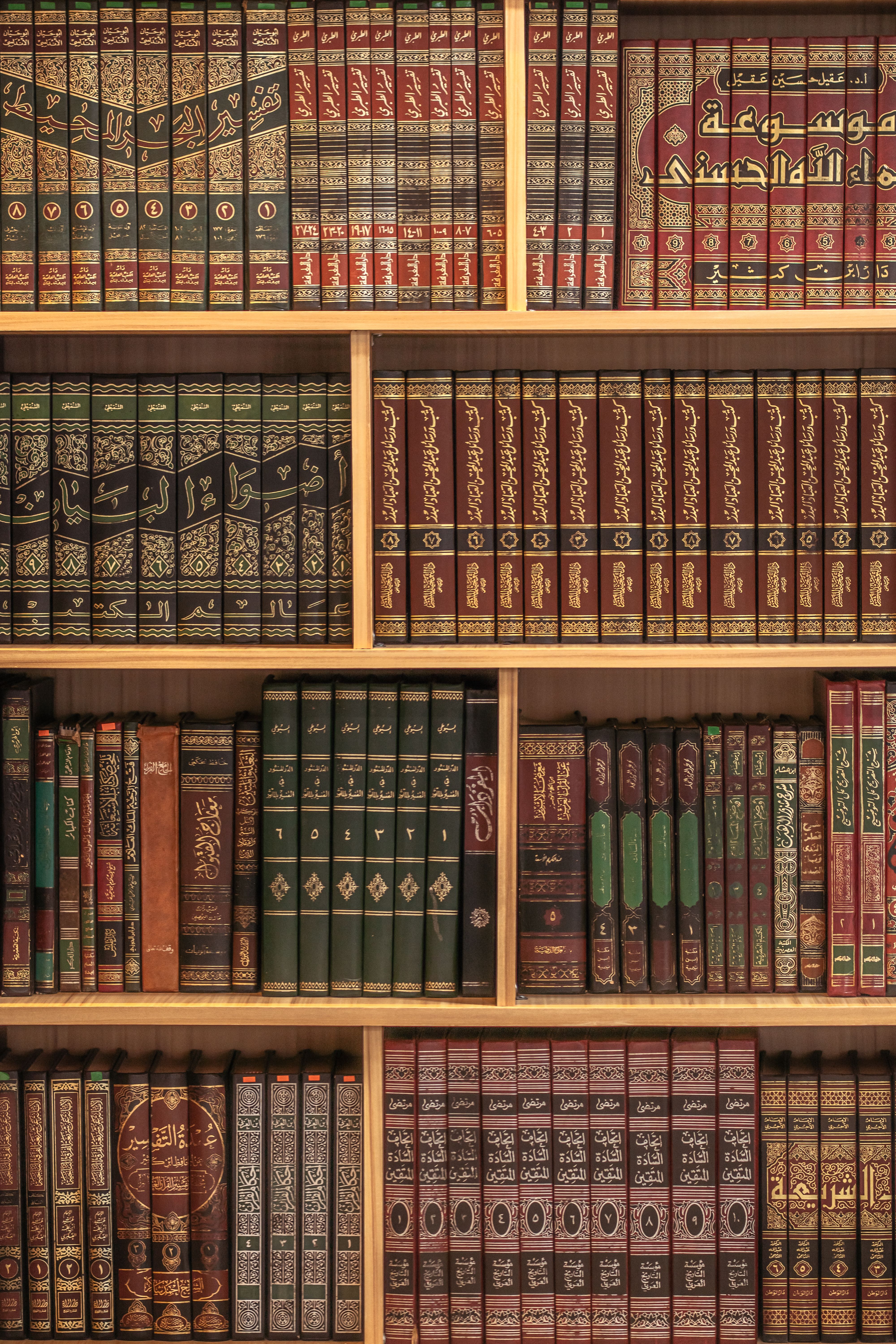 Beautifully Arranged Islamic Books on Wooden Shelves · Free Stock Photo