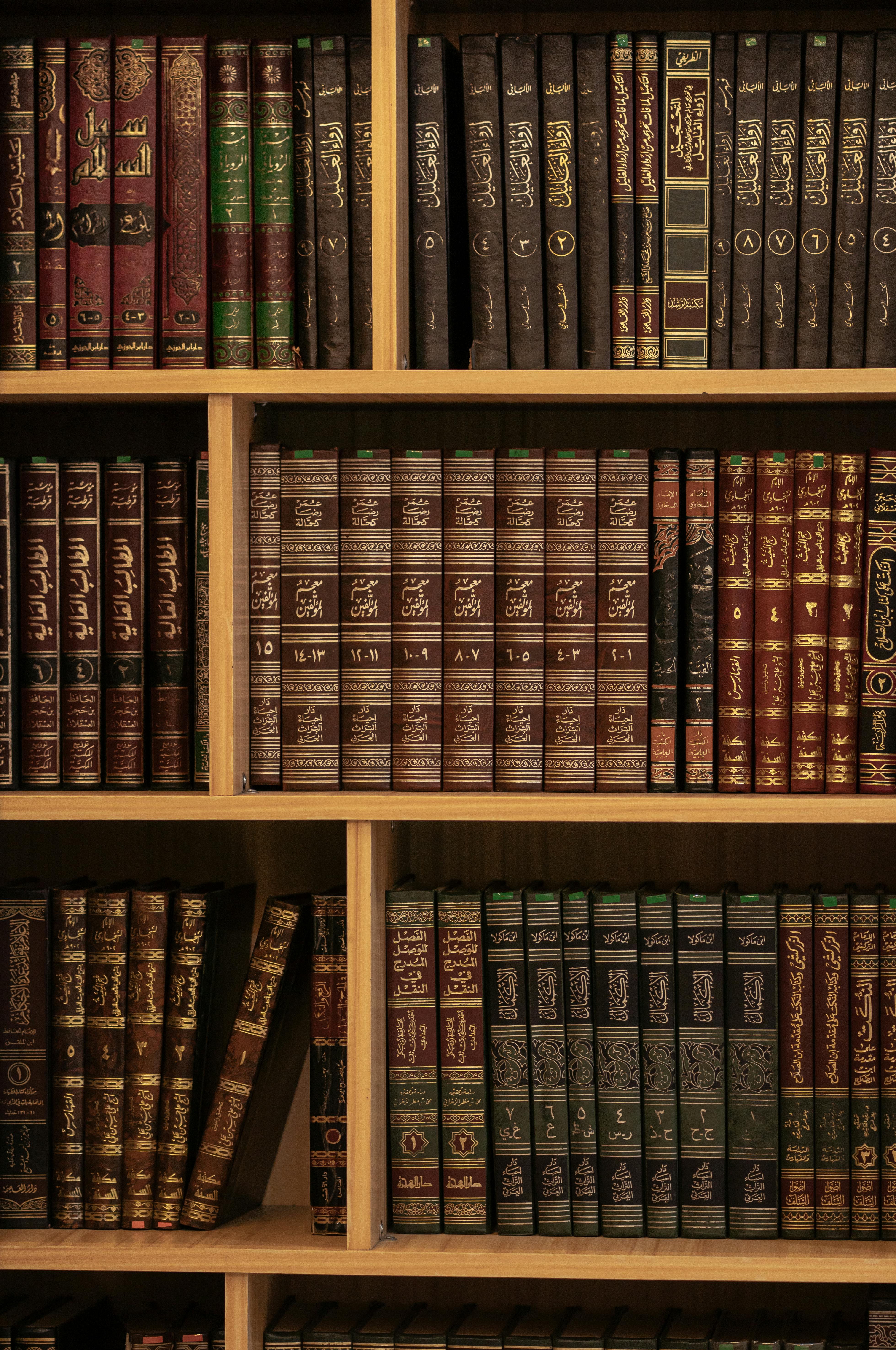Collection of Islamic Religious Books on Shelf · Free Stock Photo