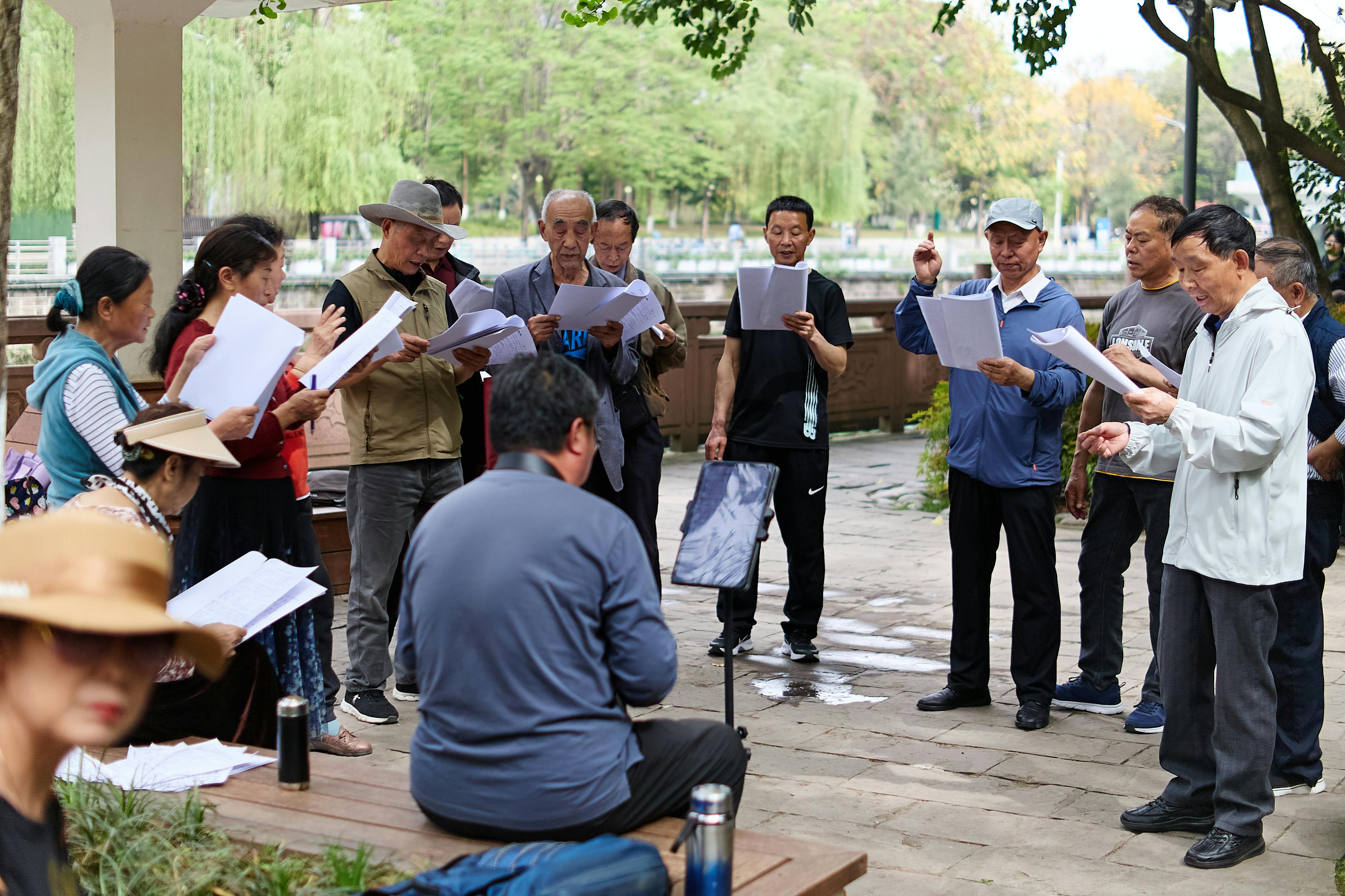 Outdoor Choir Group Singing in Park with Conductor · Free Stock Photo